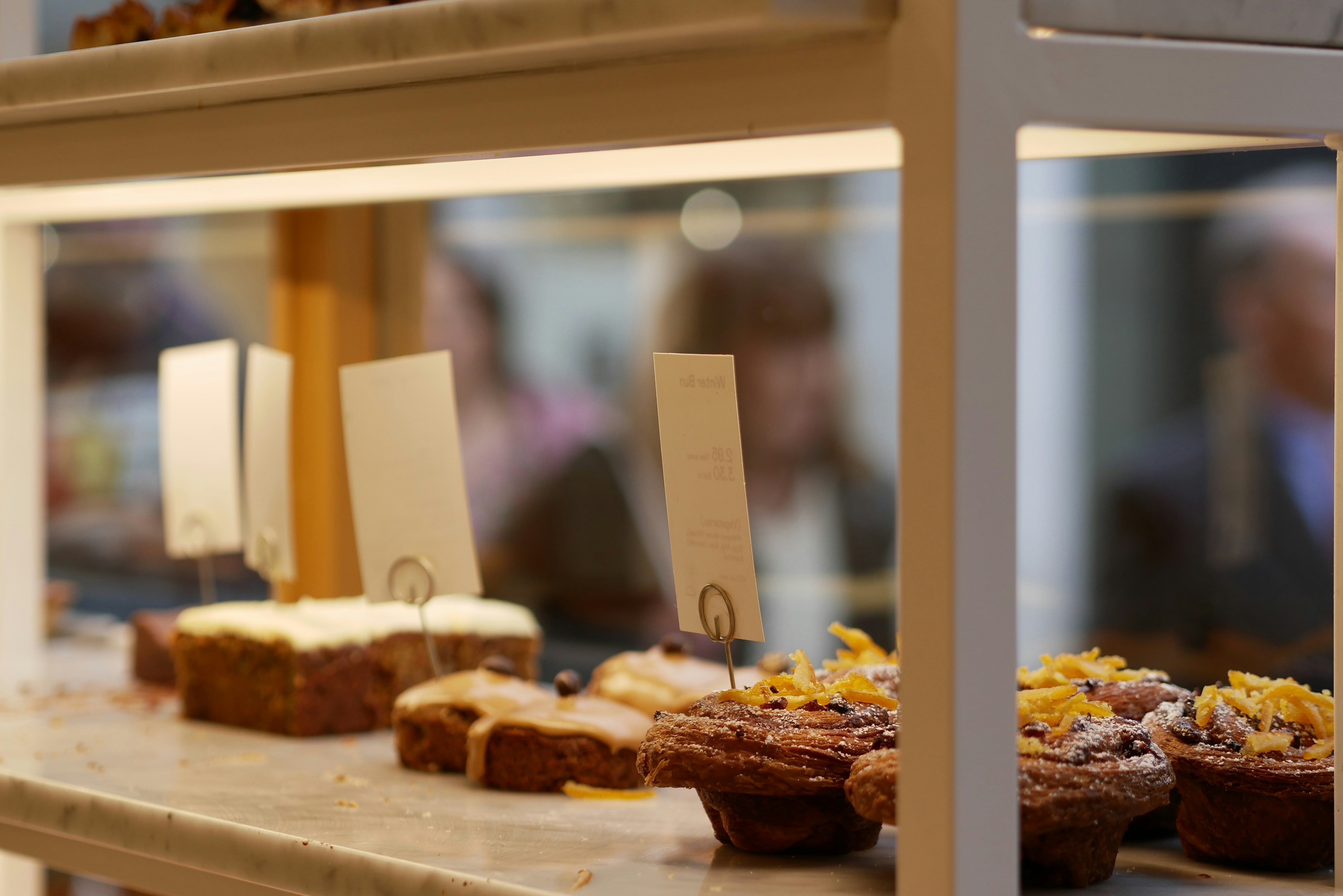 Warm pastry showcase under soft cafe lighting