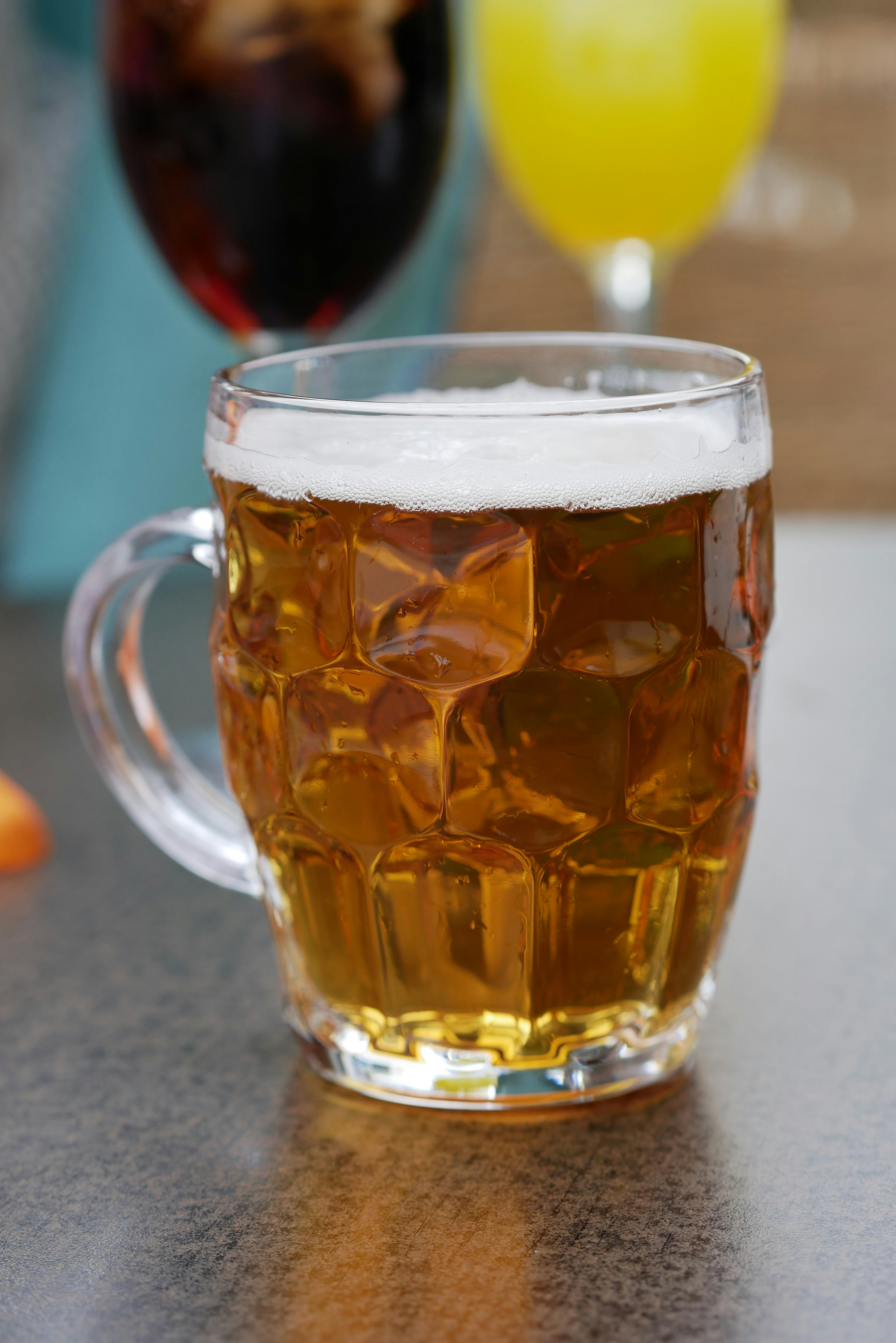 Golden Mug in Focus: A Glass of Amber on a Bar-top Stage