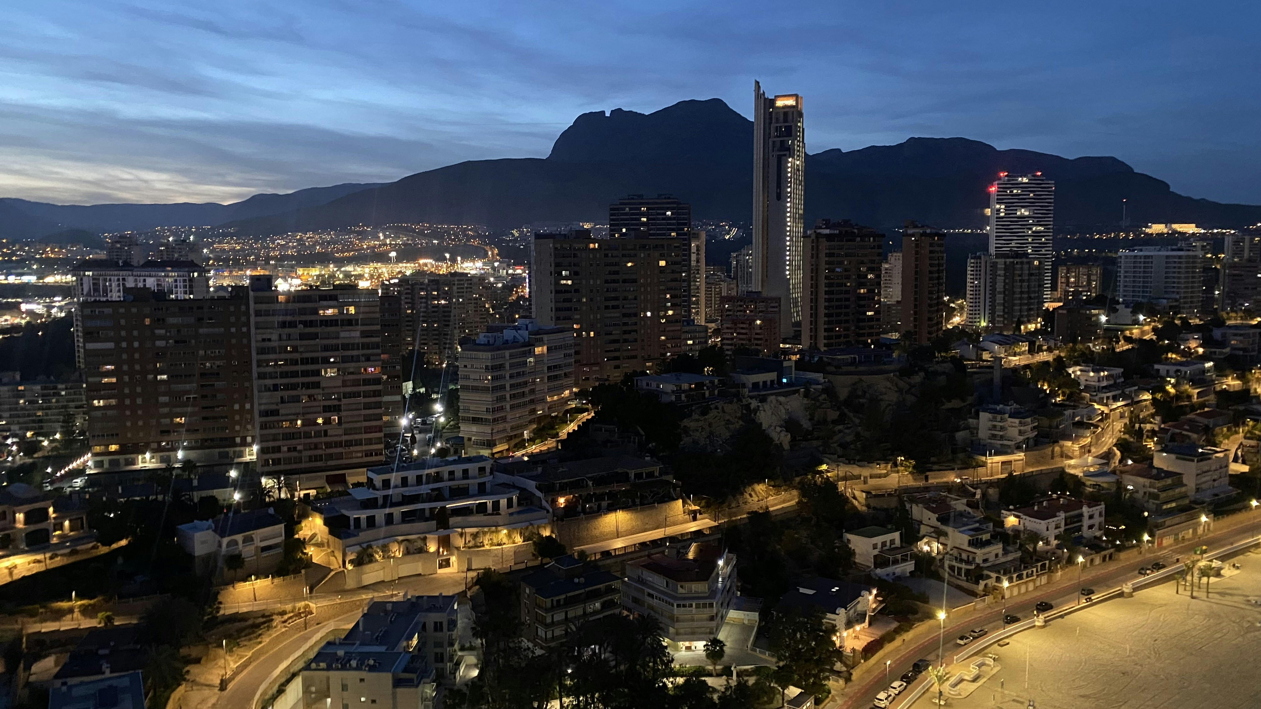City Lights Beneath a Lone Mountain