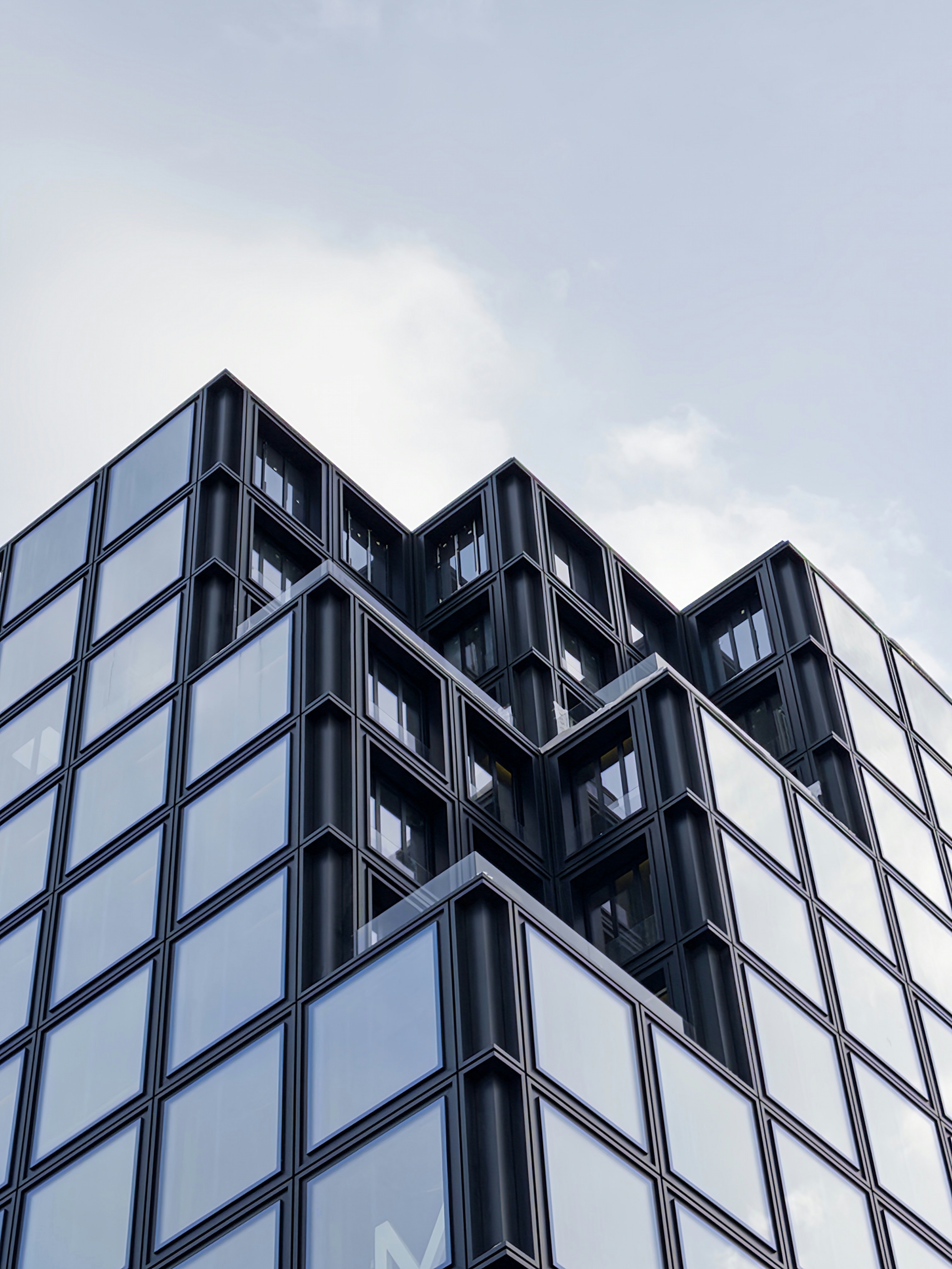 Faceted Glass Facade: Geometric Illusions on a Modern Tower