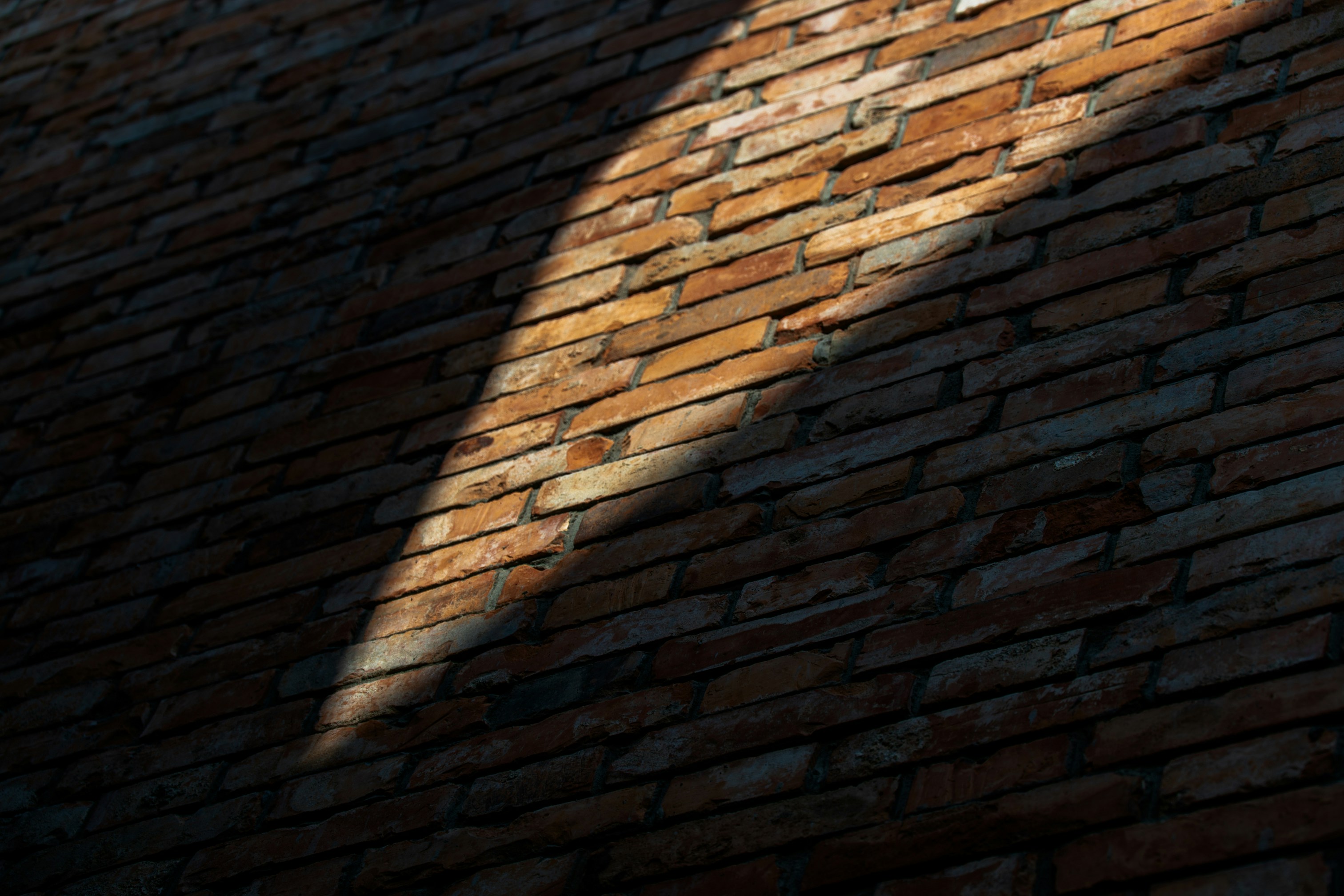 Brick Wall in Shadow: A Narrow Beam of Light Traverses the Surface
