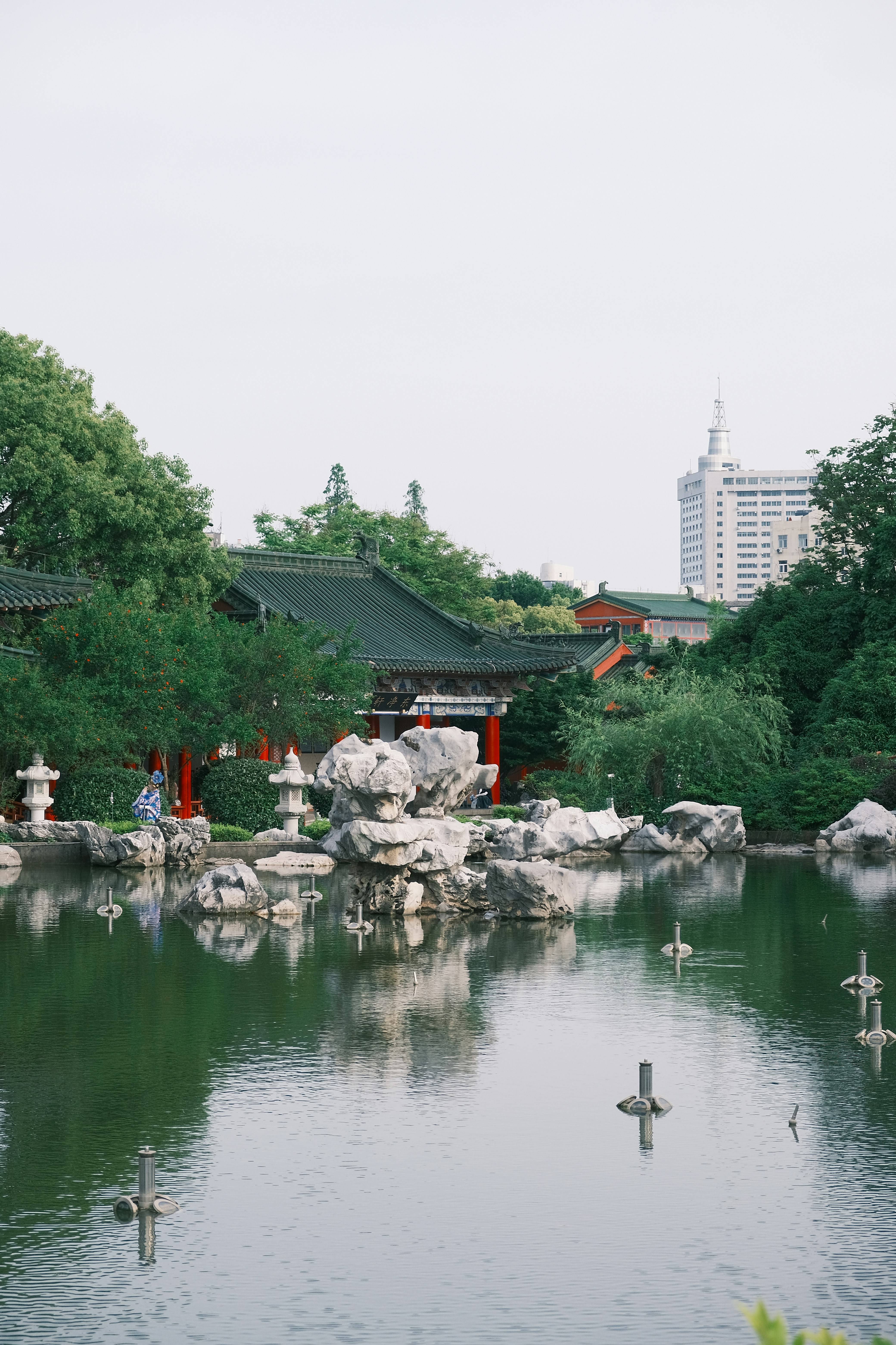 Harmony by the Pond: Traditional Pavilions and Modern Skyline