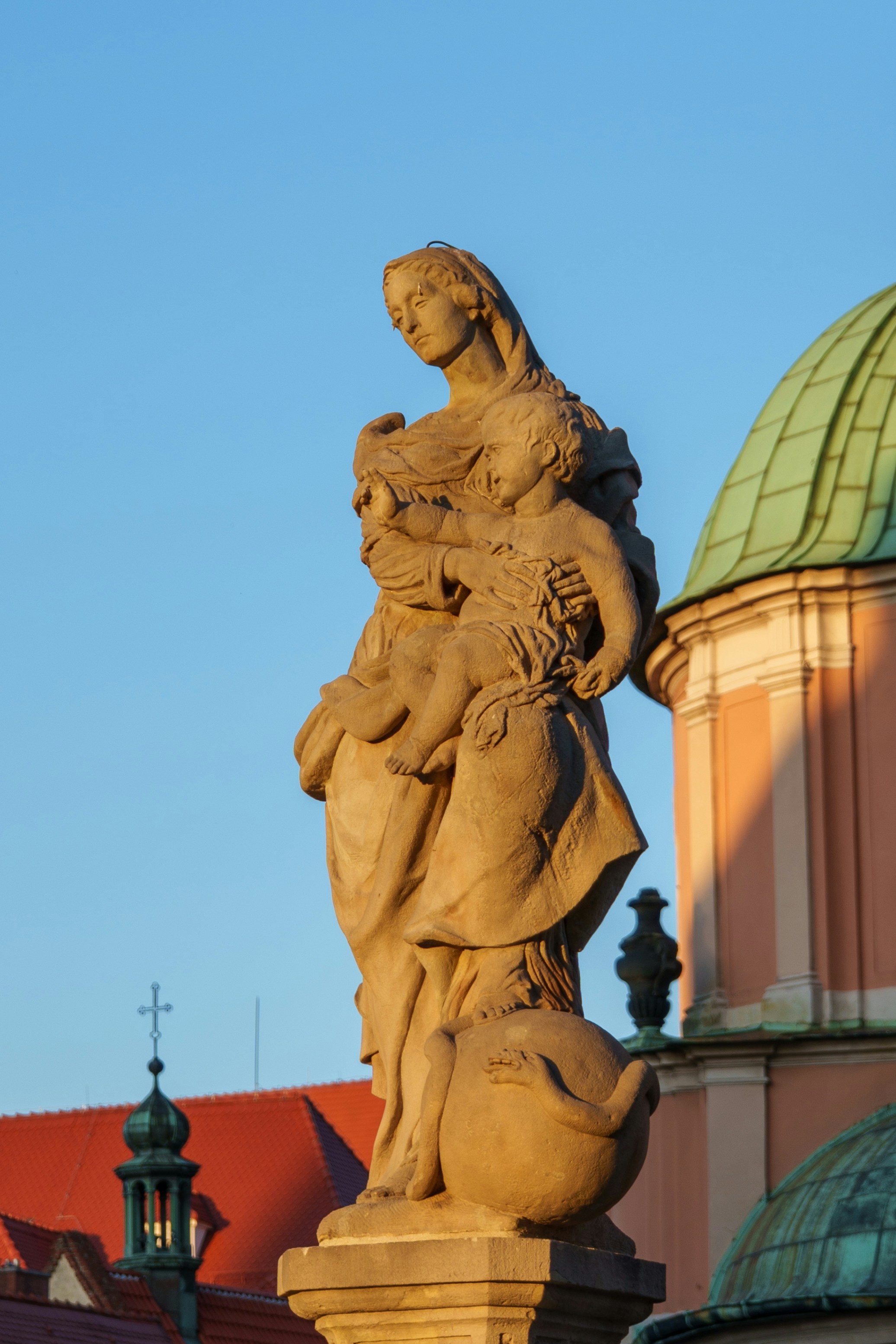 Statue of Maternal Grace Against a Calm Sky