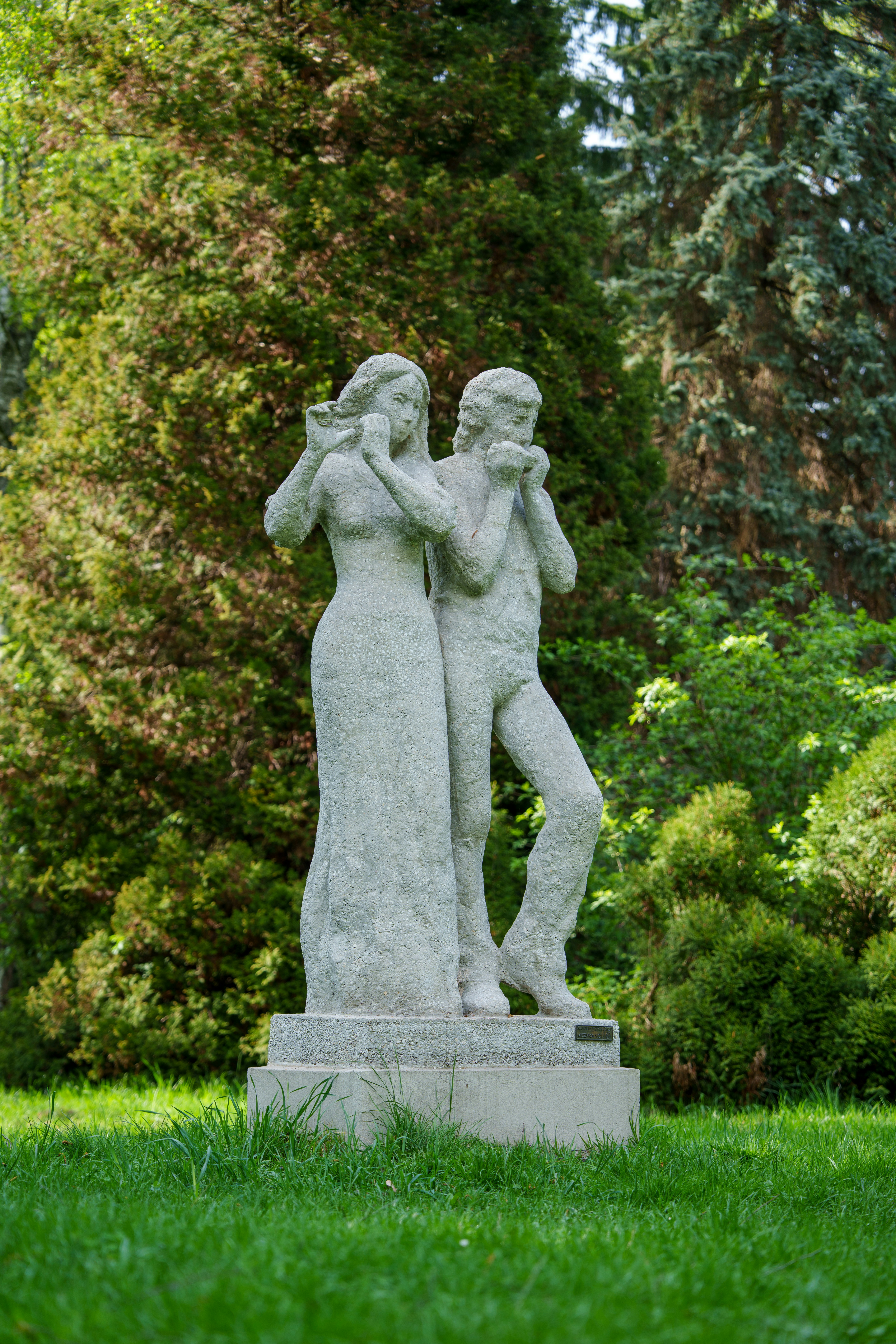 Whispering Statues: A Pair in Quiet Garden Light