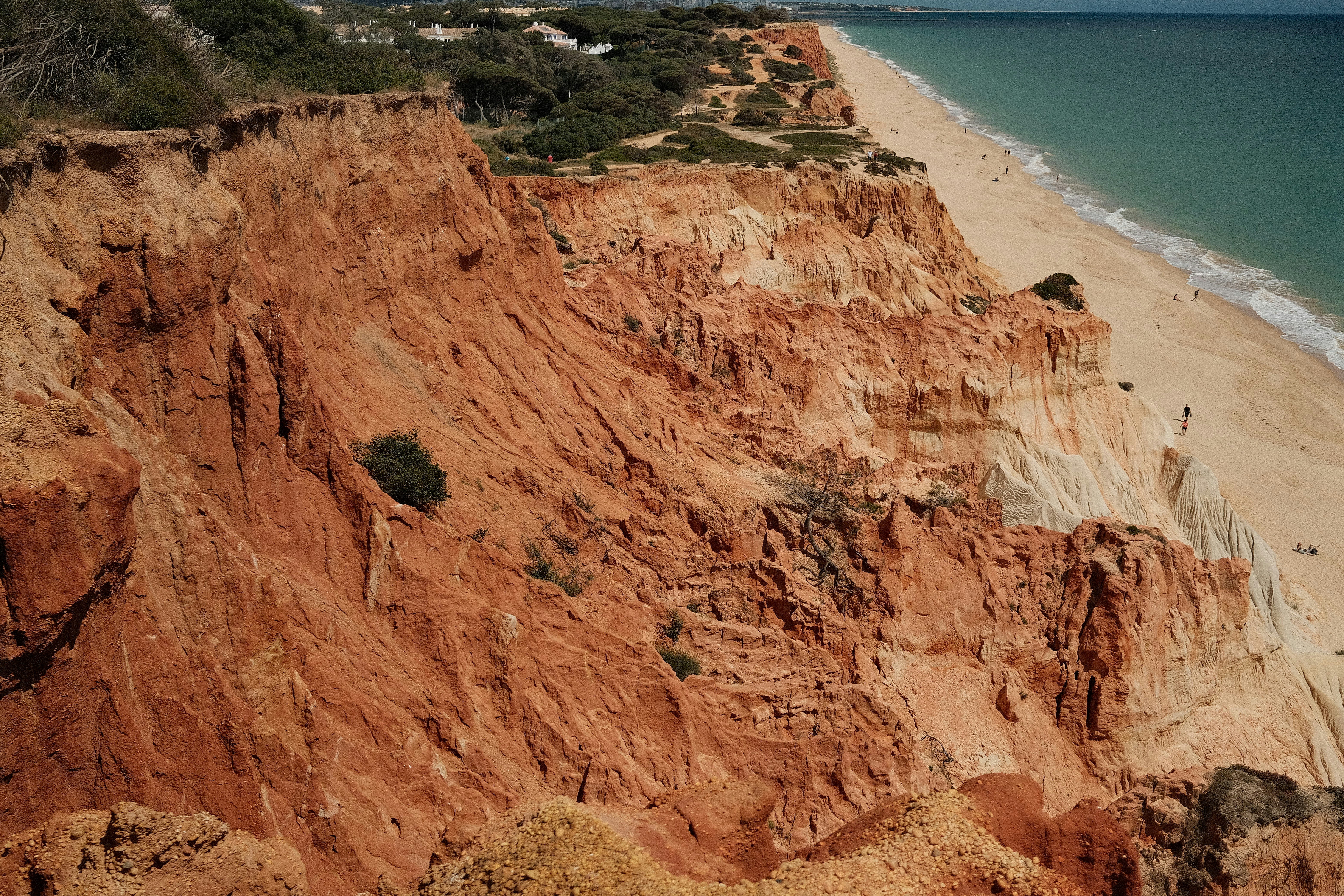 Crimson Cliffs Overlooking a Quiet Beach