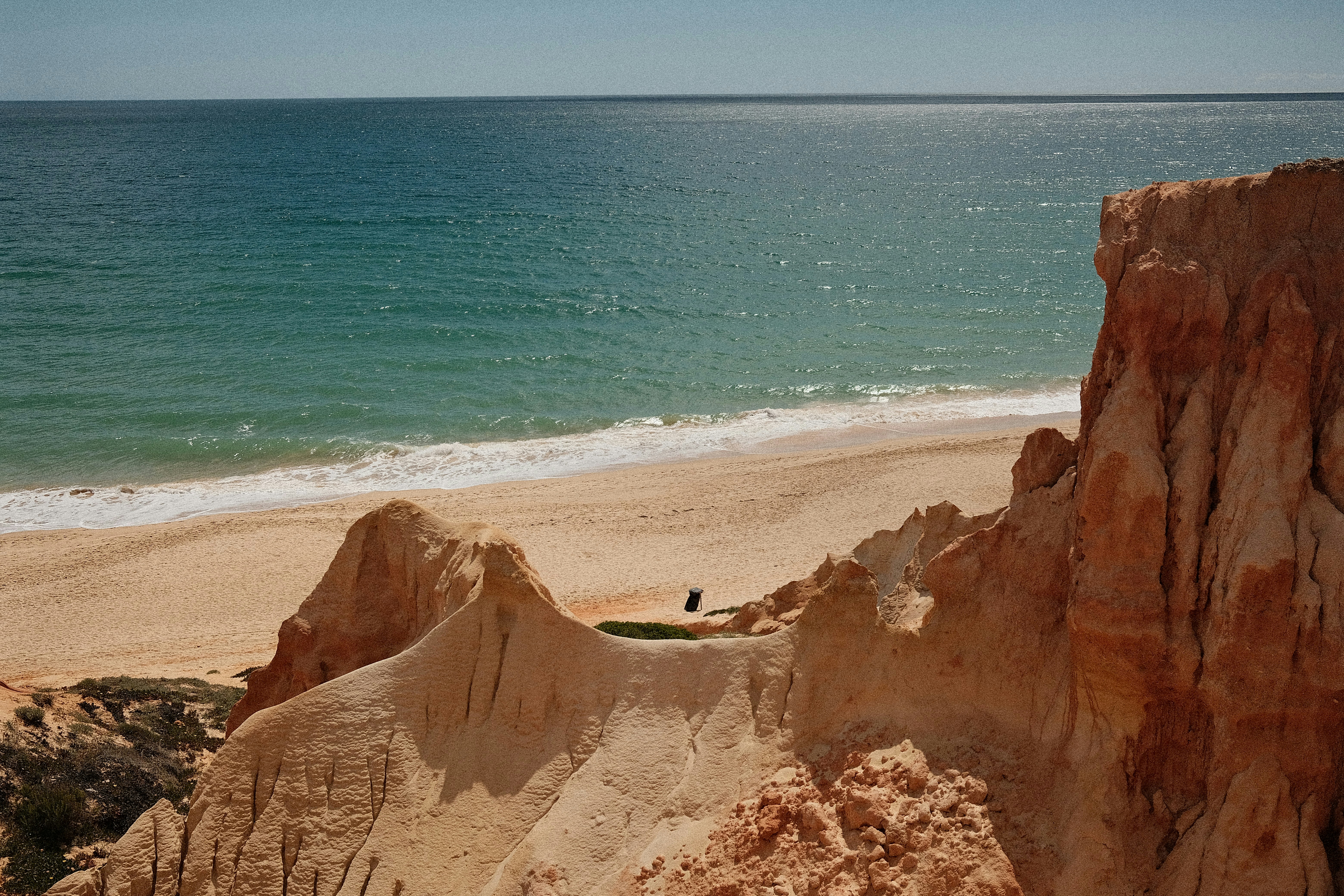 Sea Cliff Quietude: Windswept Beach Above Tidal Sands