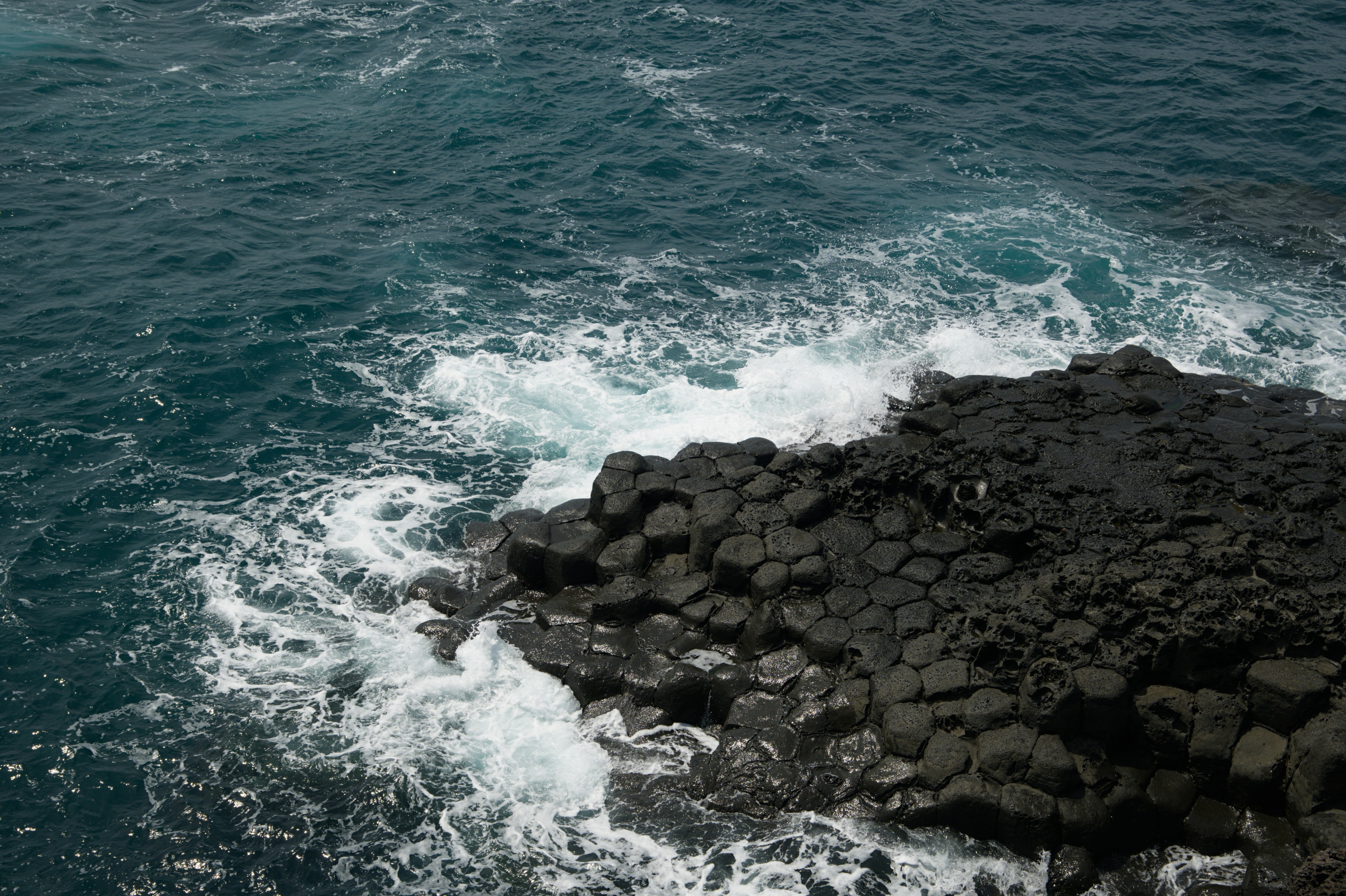 Rugged White Foam at the Edge: Lava Rock Meets Sea