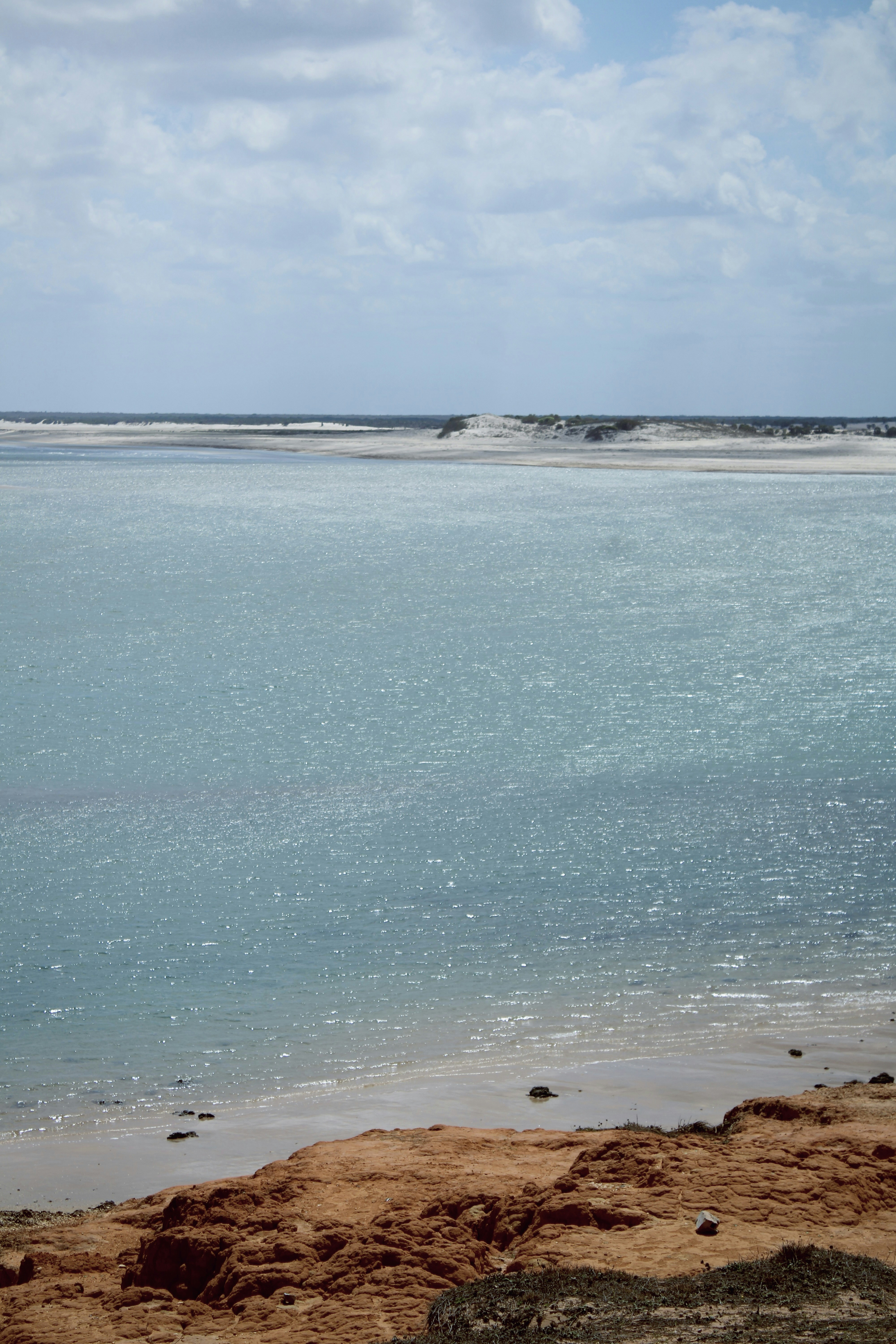 Coastal Horizon: Blue Calm and Rusty Shore