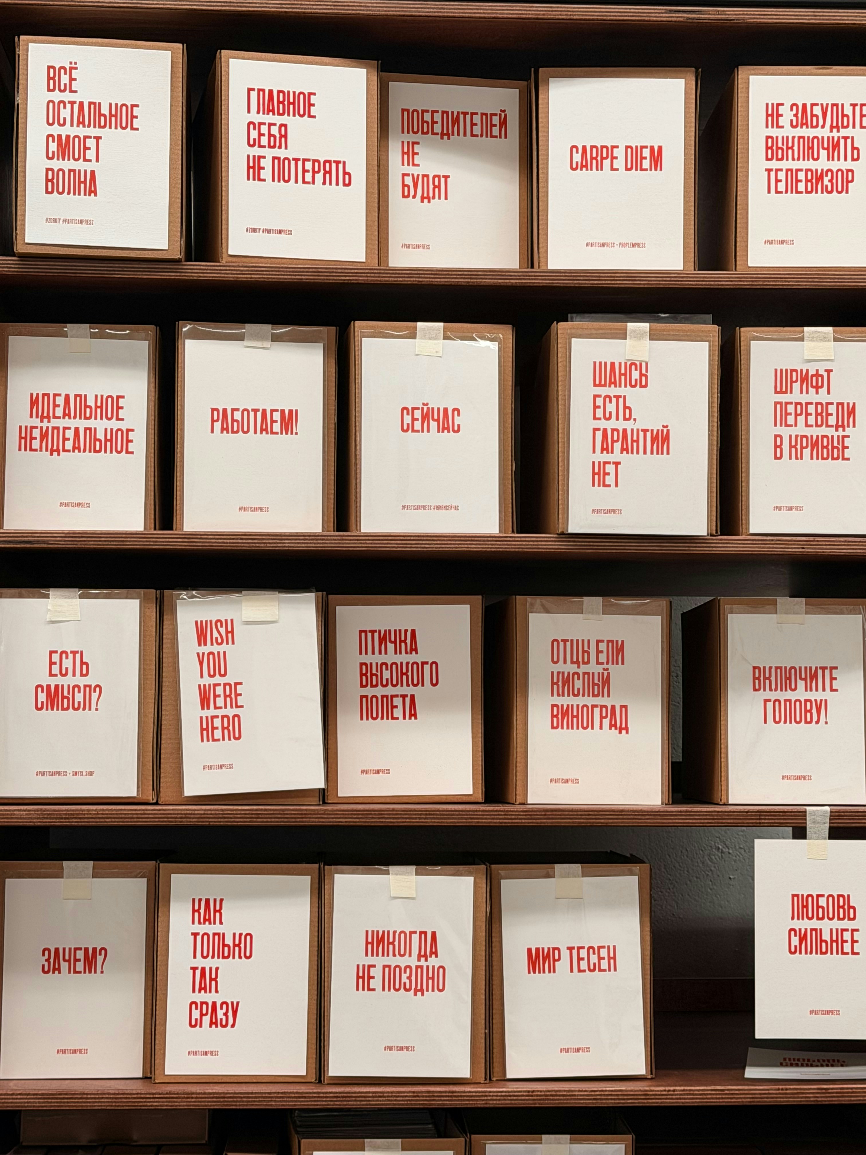 Typography Gallery: Rows of Red-Text Cards on Wooden Shelves