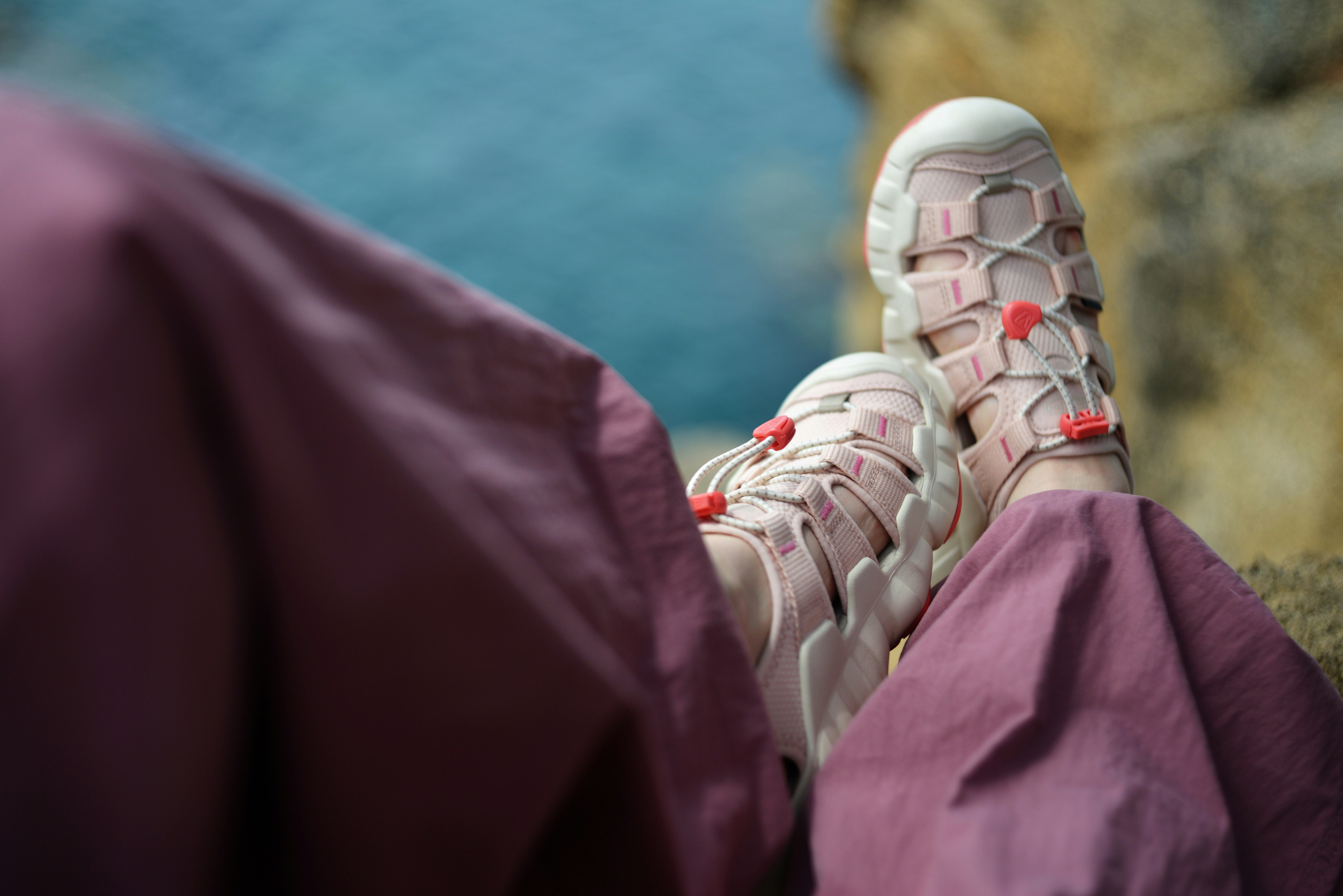 Paused in Pink: Feet Resting Over the Edge of a Cliff