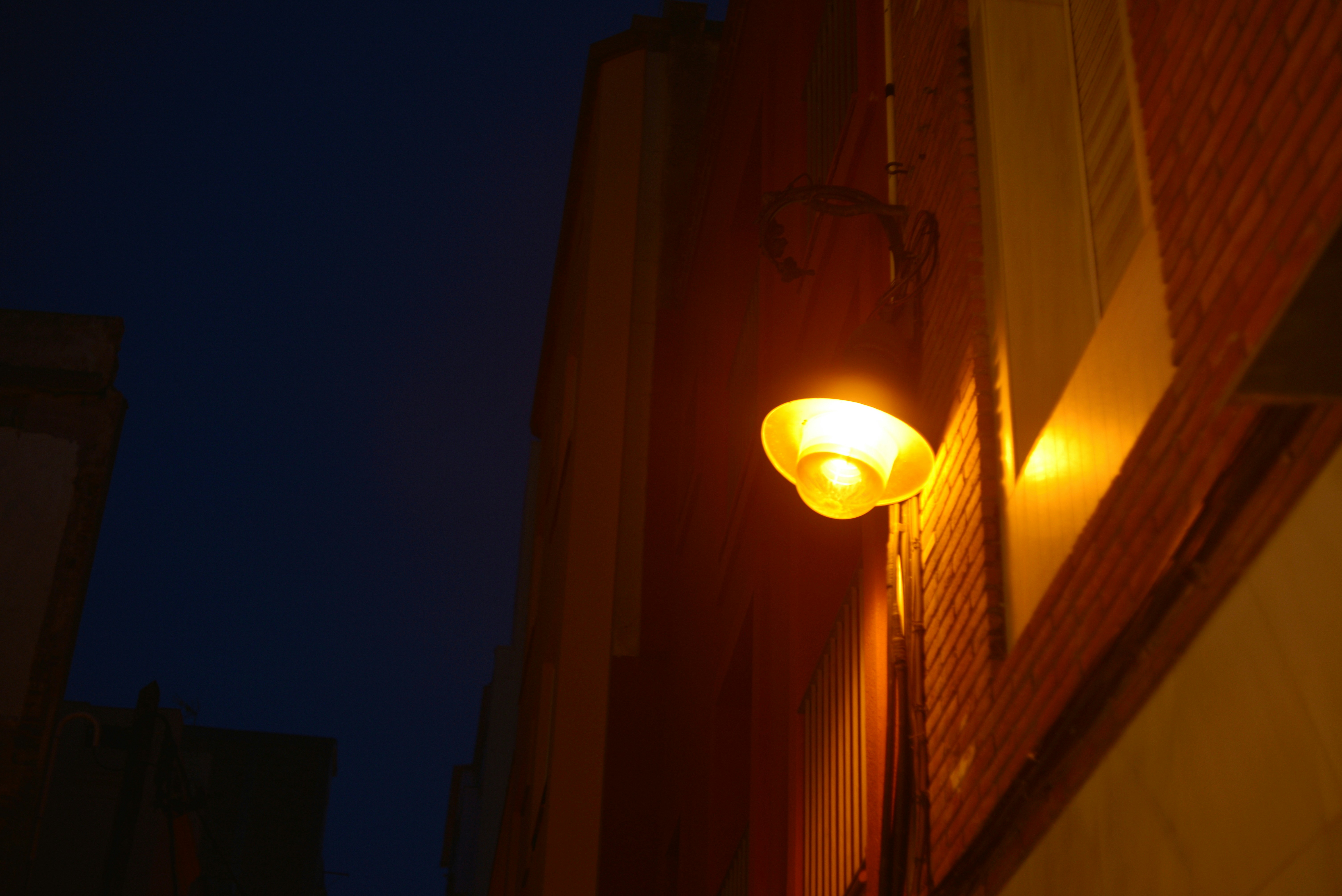 Golden Gloaming: A Streetlamp Casts Echoes on Brick
