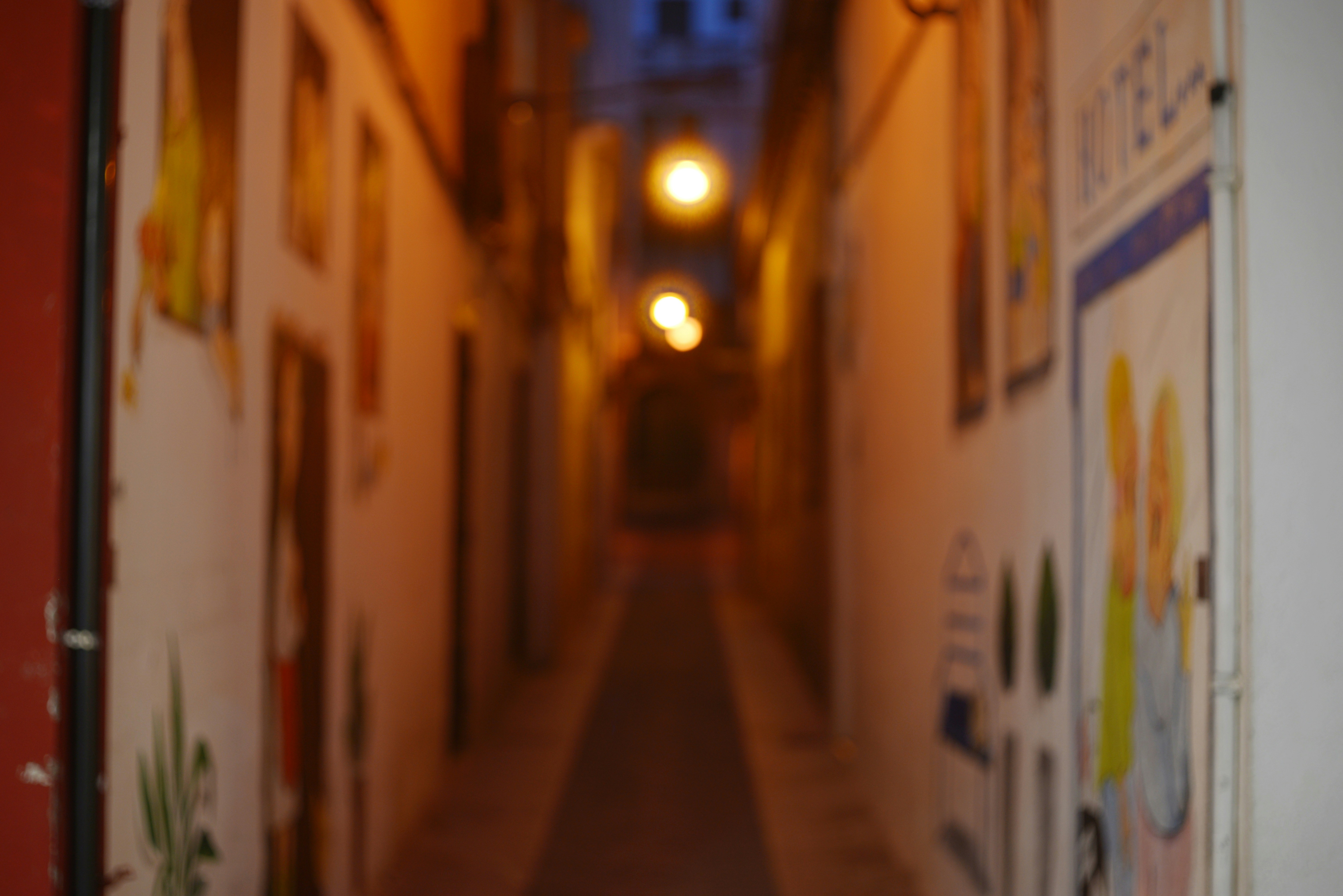 Blurred Alleyway Lanterns: A Soft Glimpse Through Narrow Walls