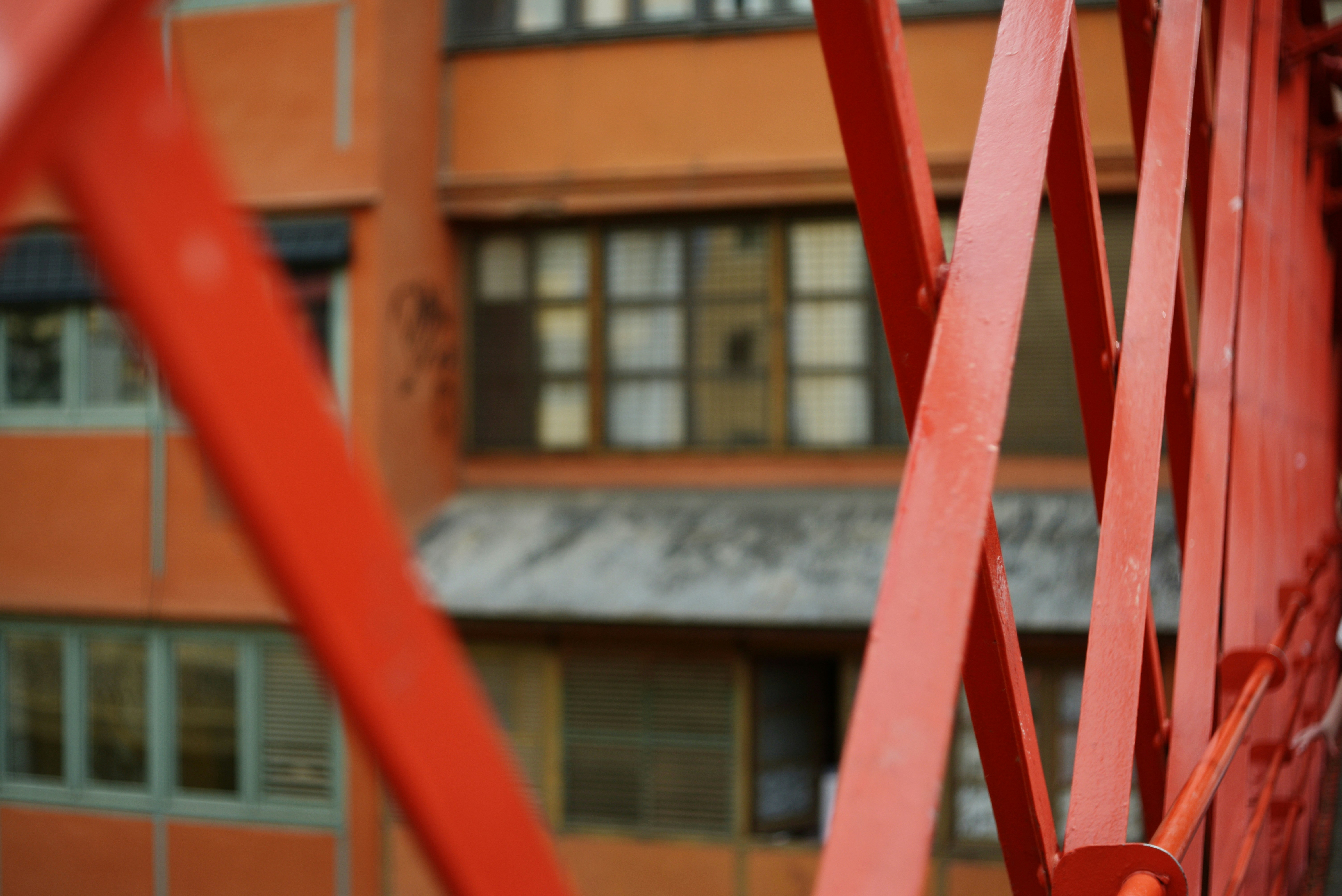 Crimson Lattice: Red beams against a brick backdrop