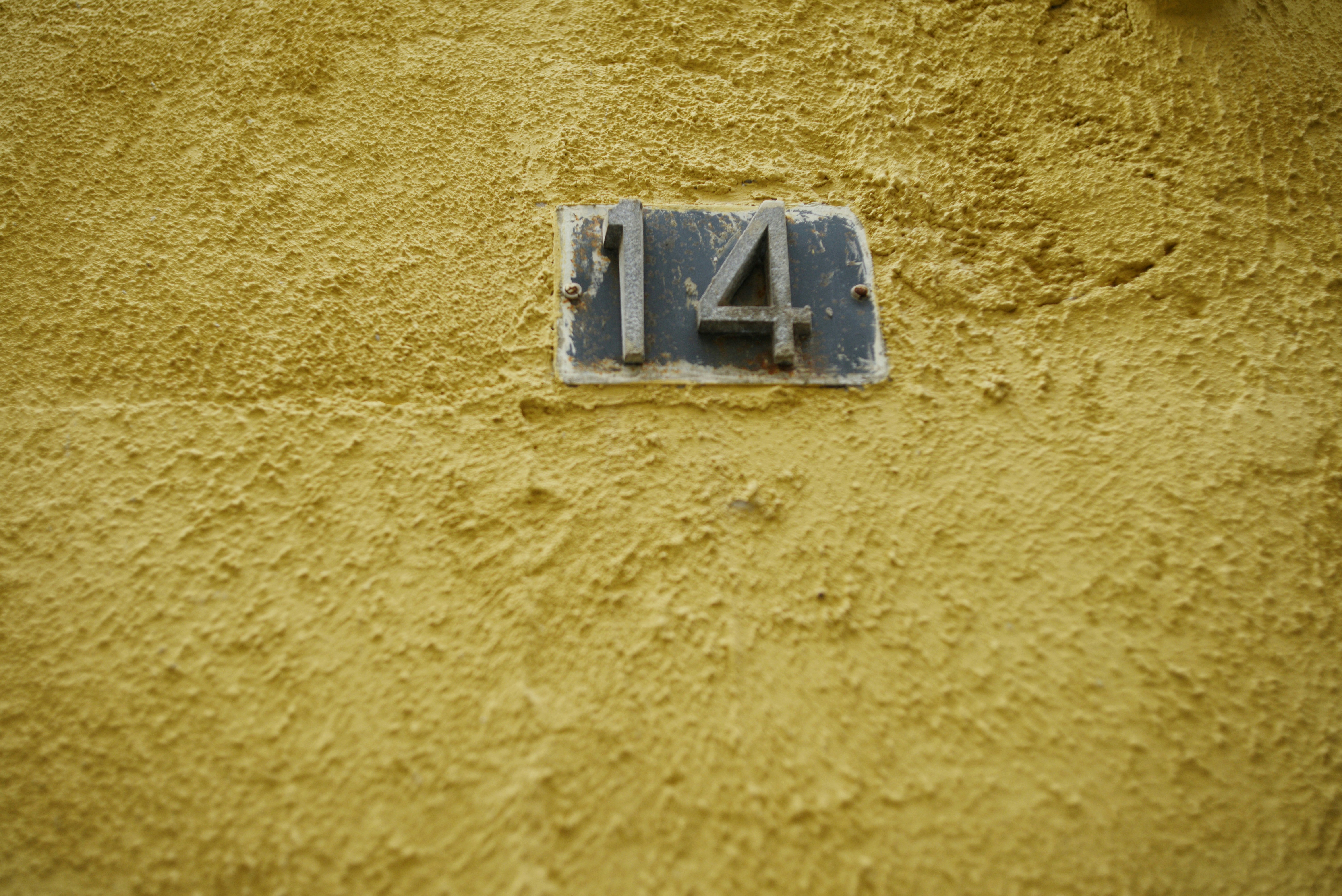 Lodged Address on a Sunlit Yellow Wall