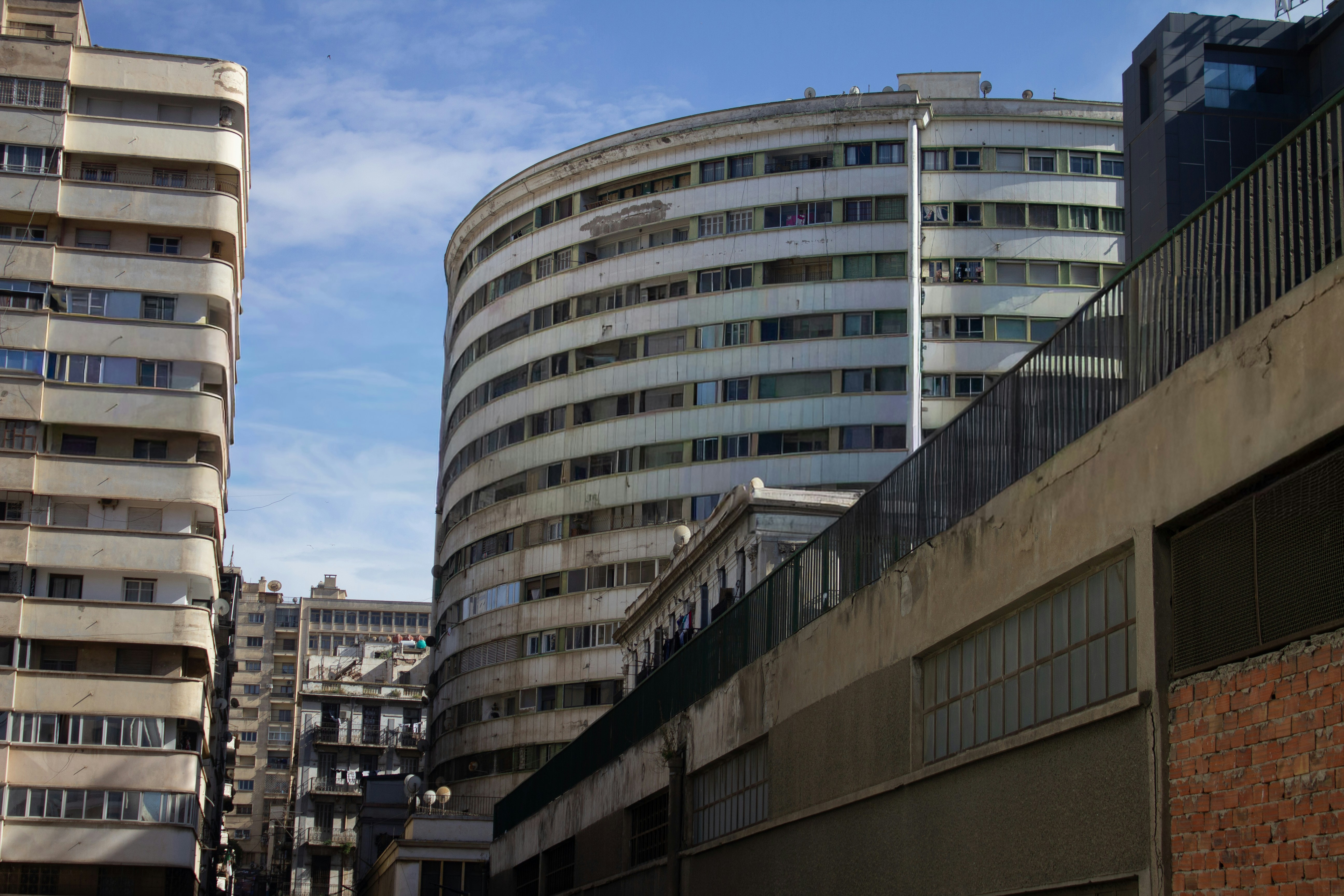 Curved White Facade Amid Urban Grid