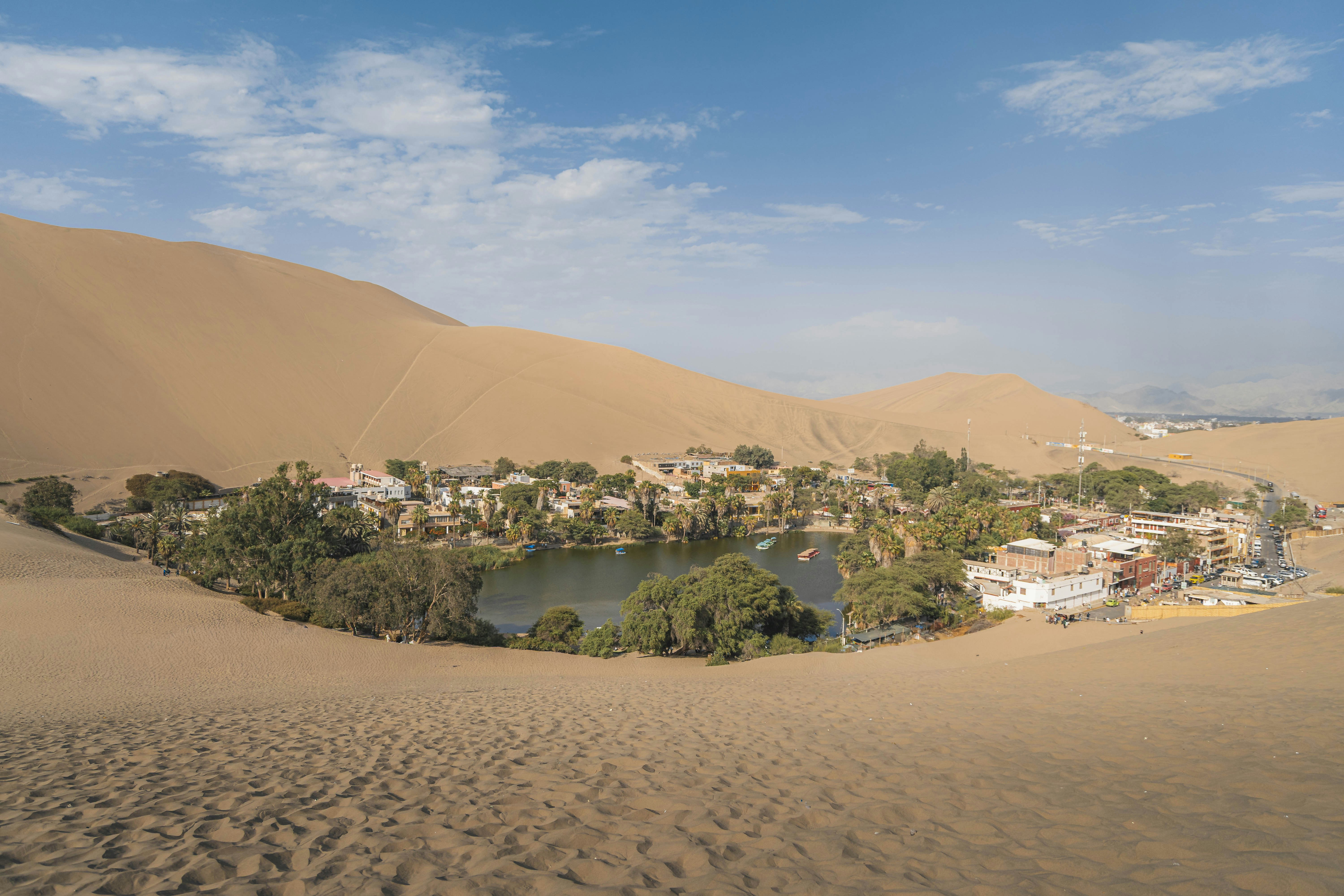 Oasis on the Dune: Village tucked beneath a crescent of sand