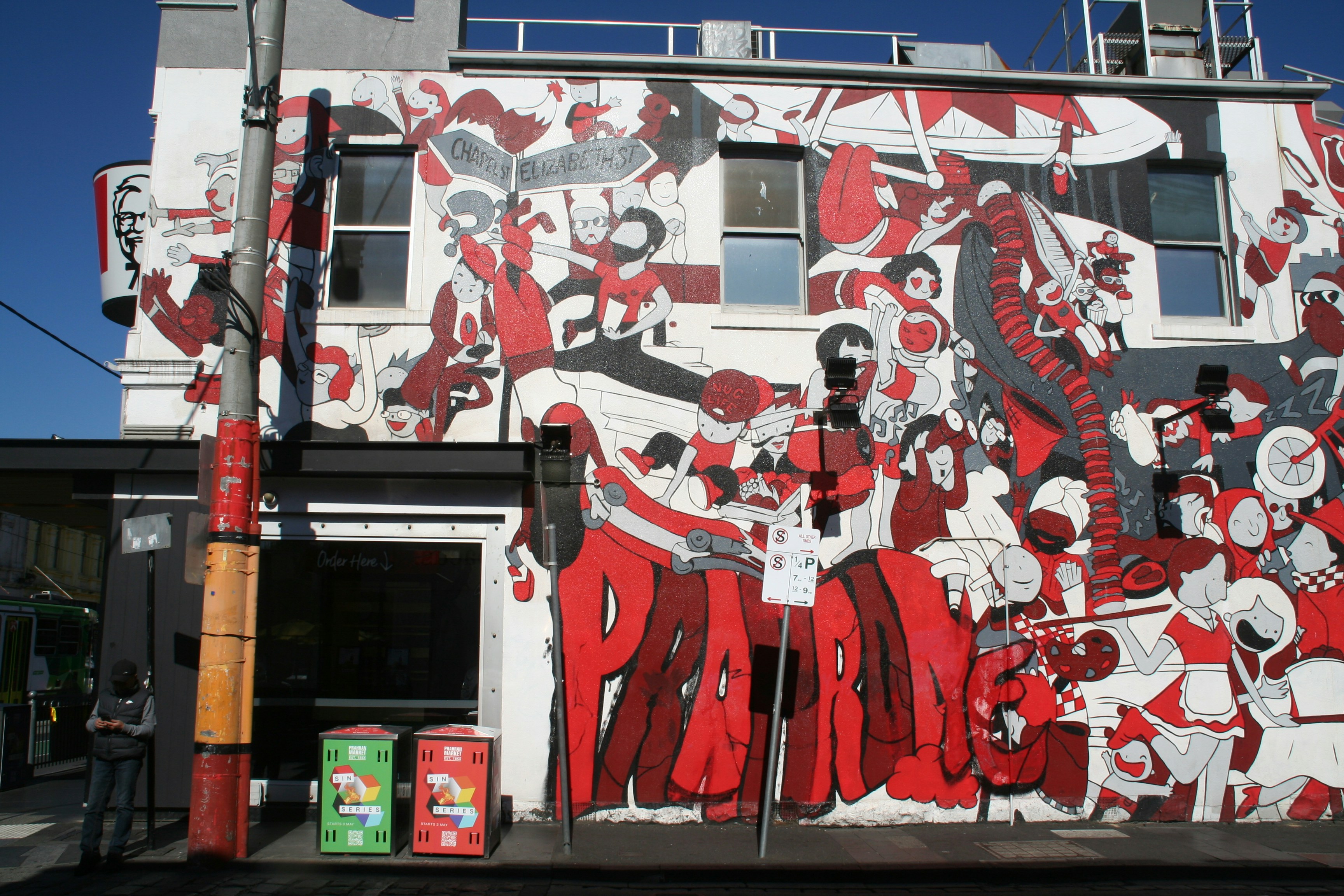 Red-Hued Chorus: A Street-Willed Mural of City Life