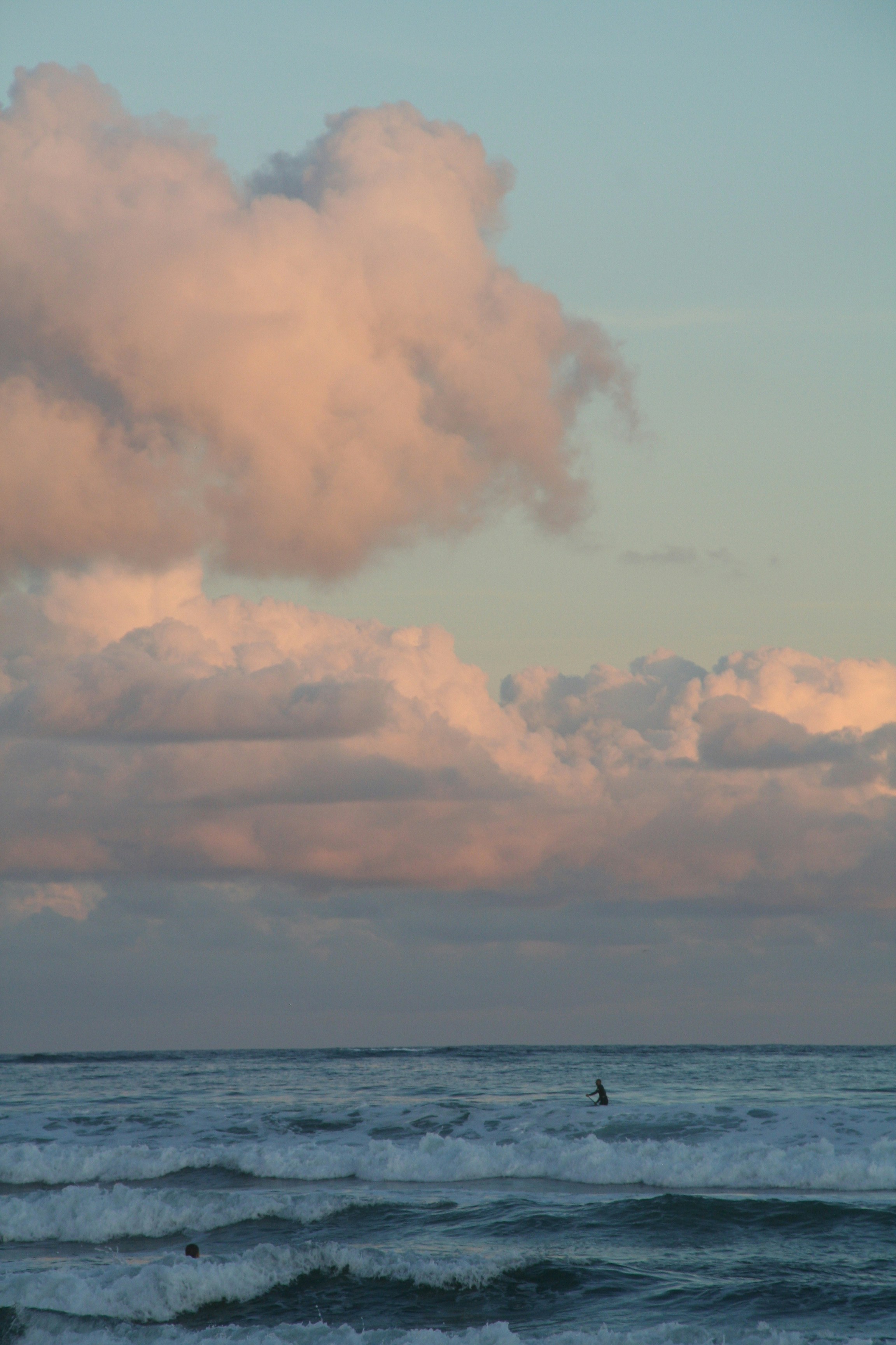 Horizon Quiet: A Lone Surfer at Dusk