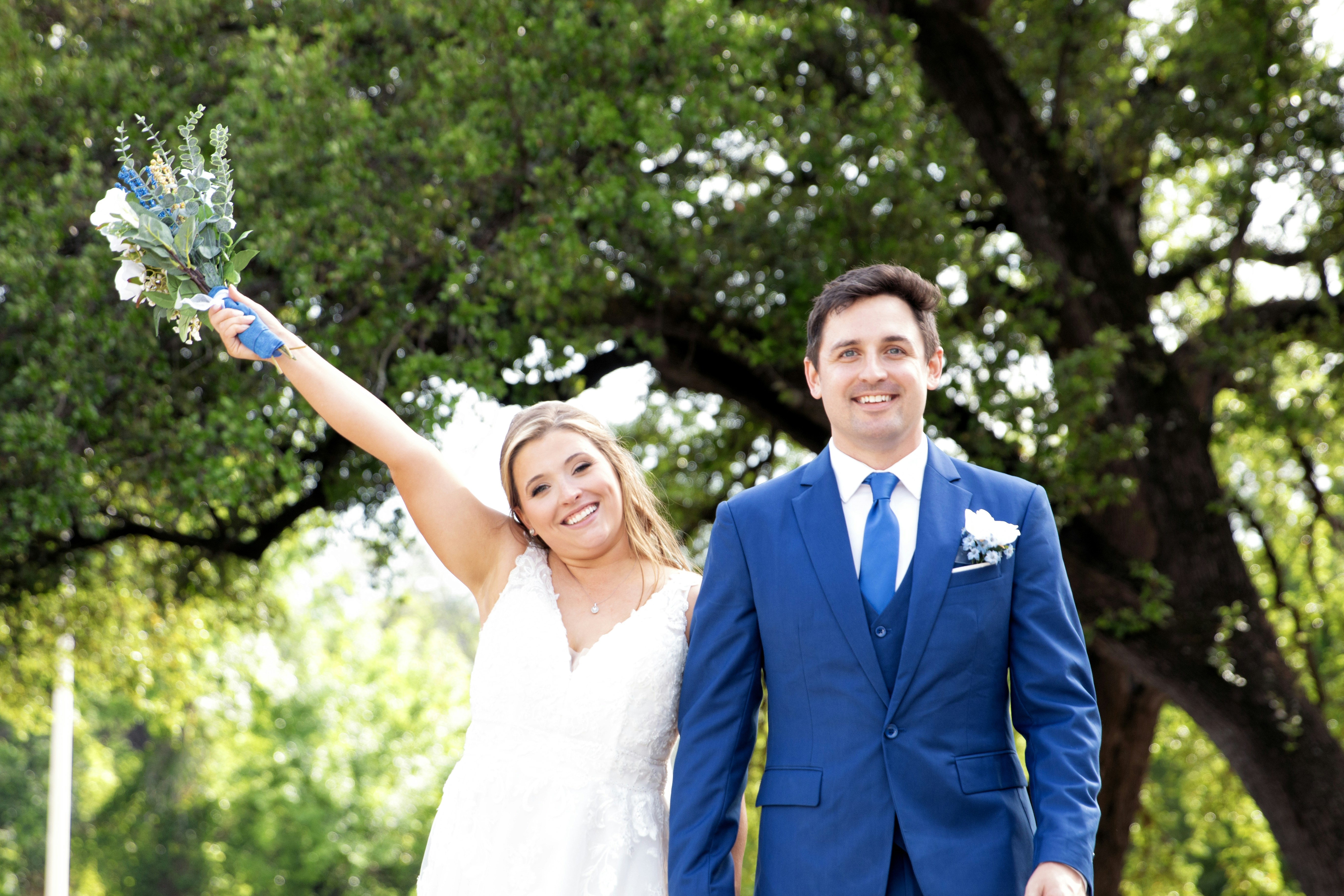 Joyful Union: Bride and Groom Step into Bright Summer Light