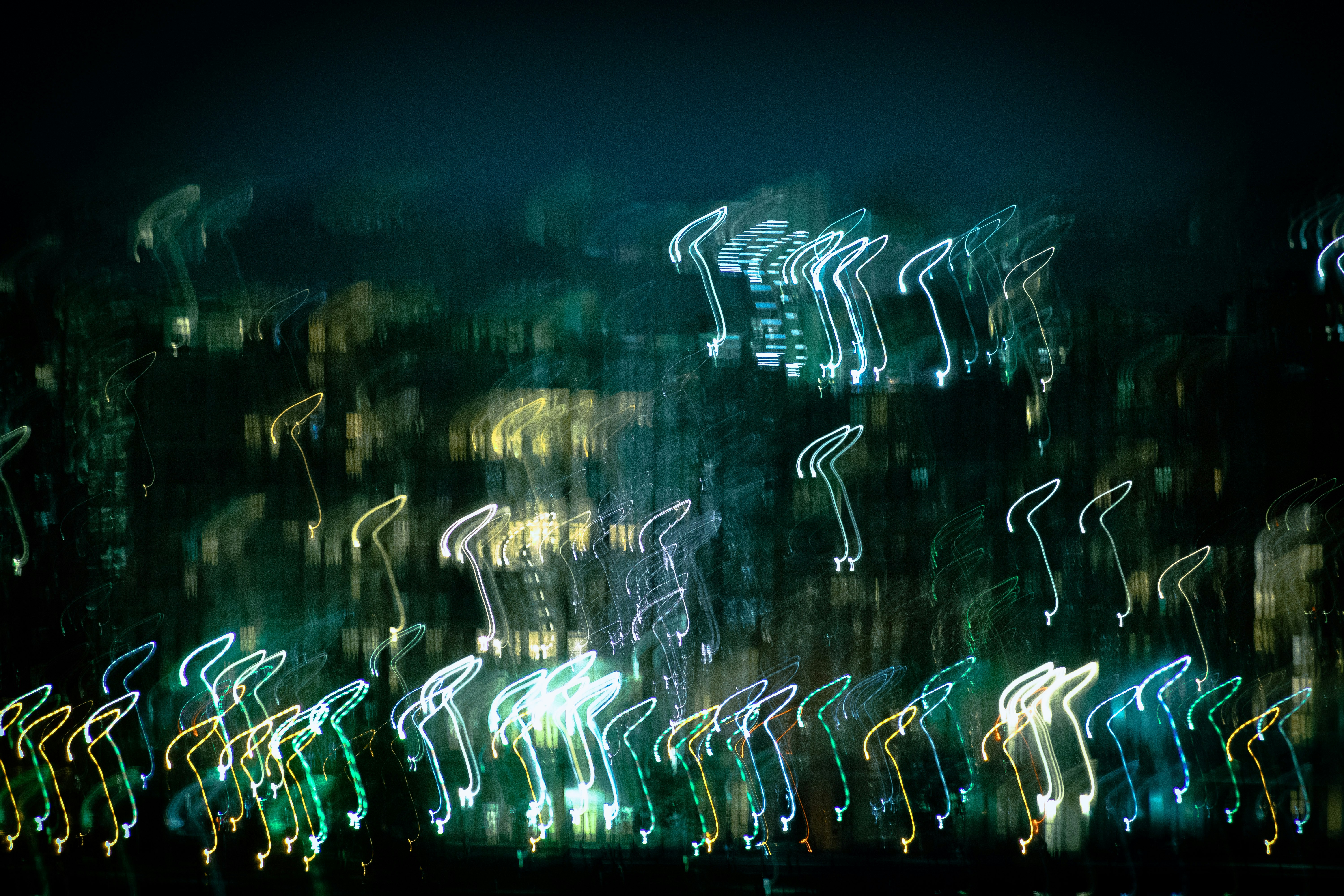 Luminous Streaks Over City Lights