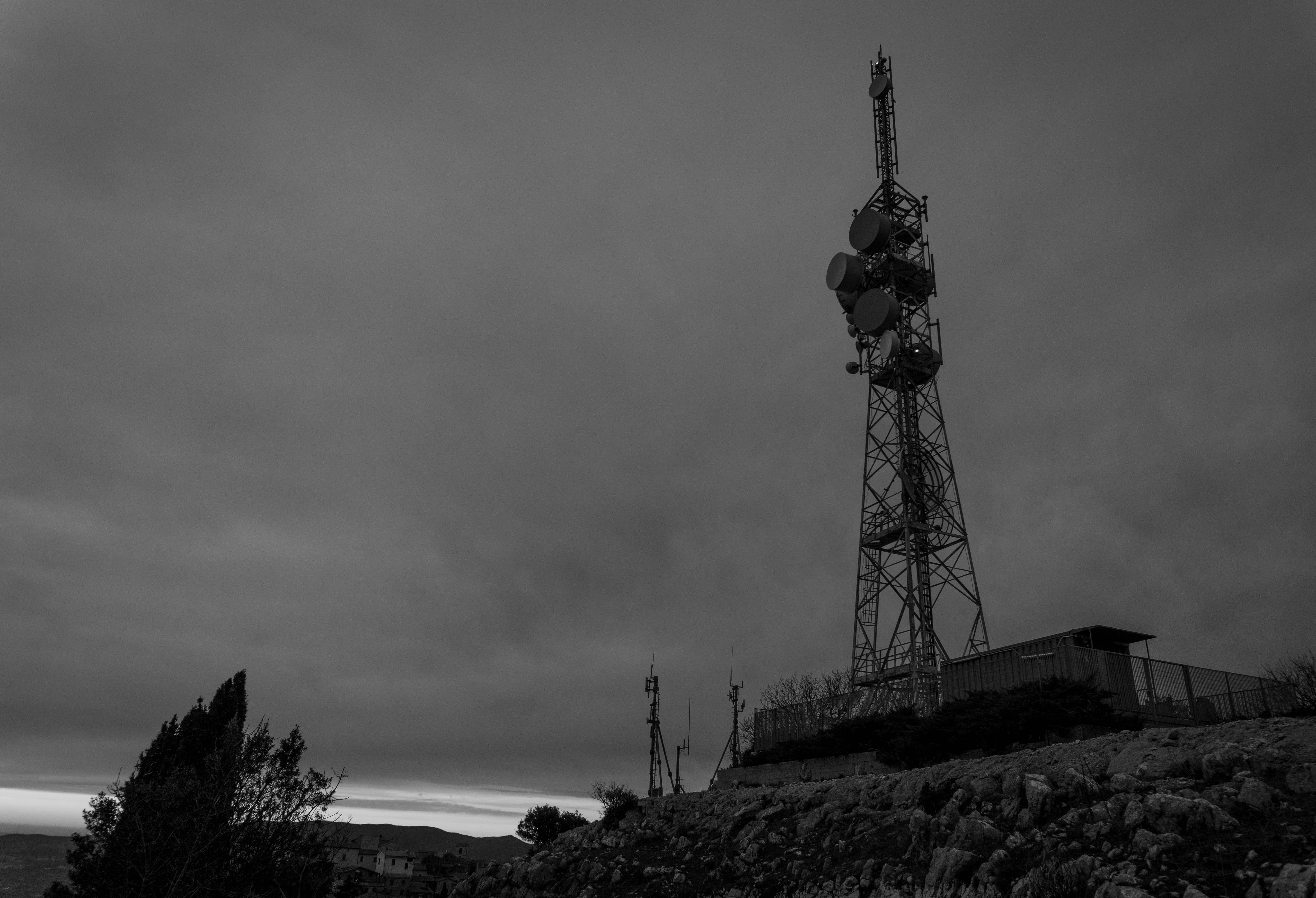 Skyward Beacon: A Quiet Coastal Tower Against Dramatic Clouds