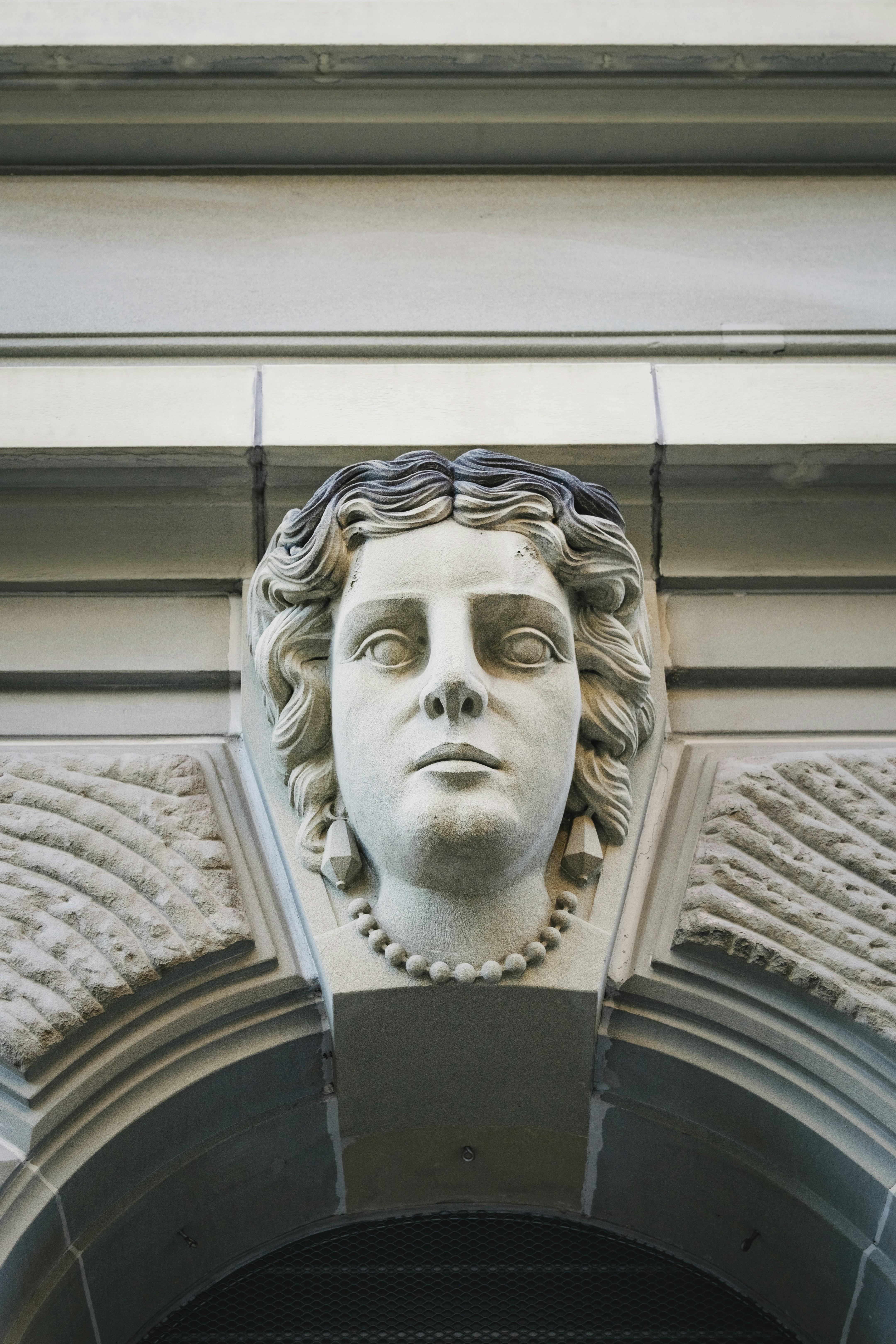 Stone Portrait Over the Arch: A Carved Headwatching Over the Entrance