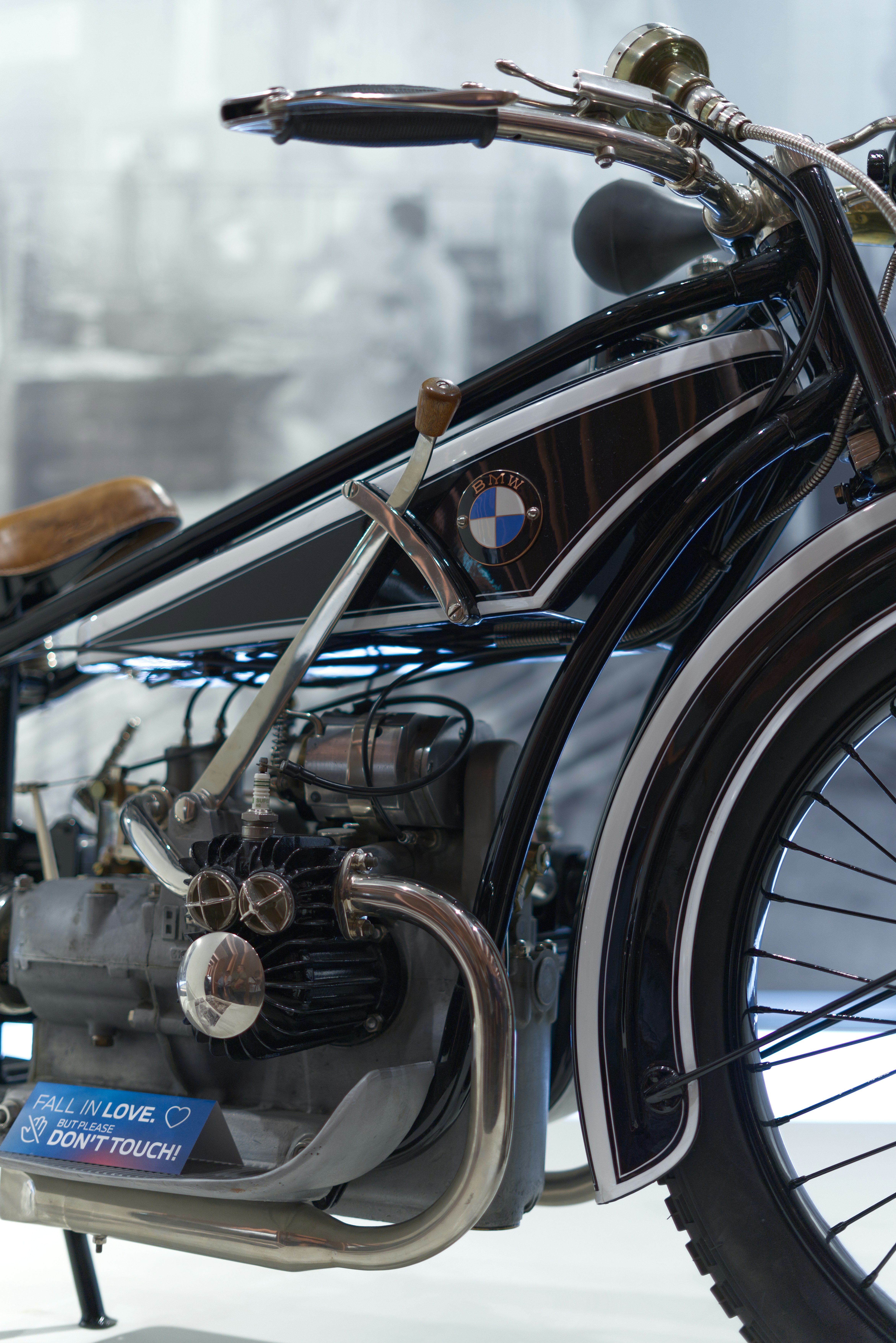 Classic BMW Motorcycle: chrome piping and emblem in a showroom glow