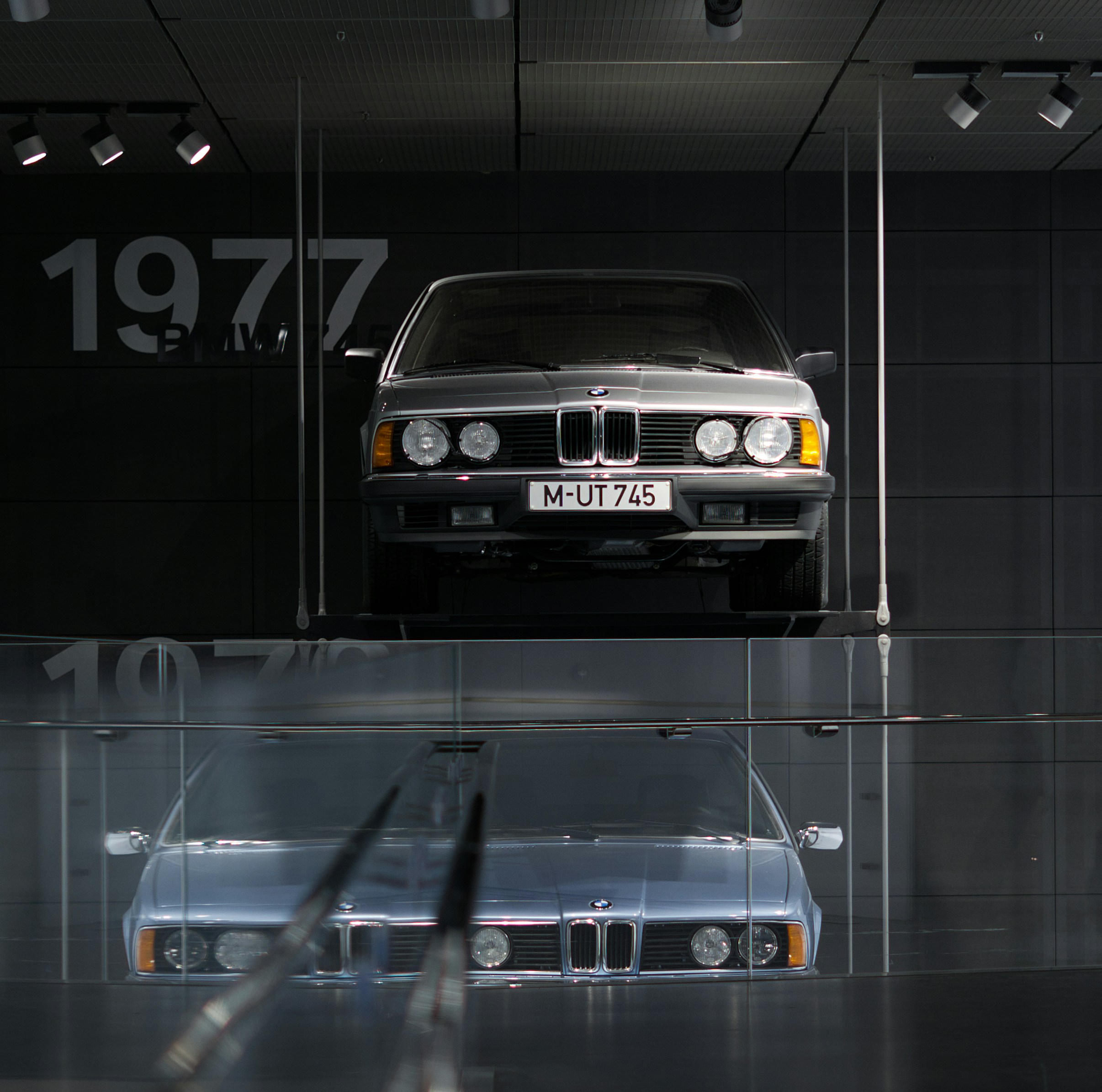 Suspended Classic: BMW E30 Elevated in a Glass-encased Gallery