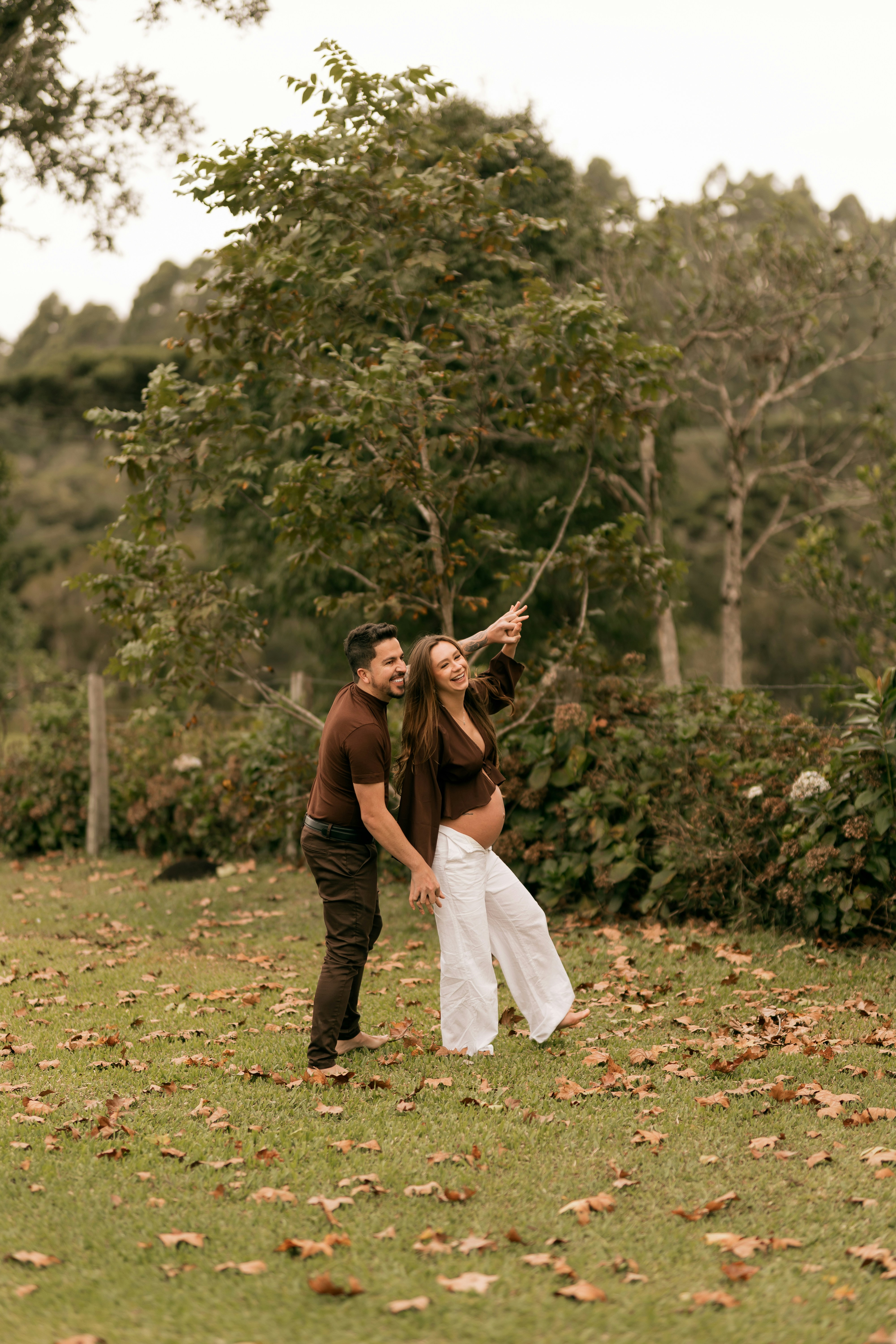 Behind-the-Scenes Waltz: A Couple's Lift in Autumn Light
