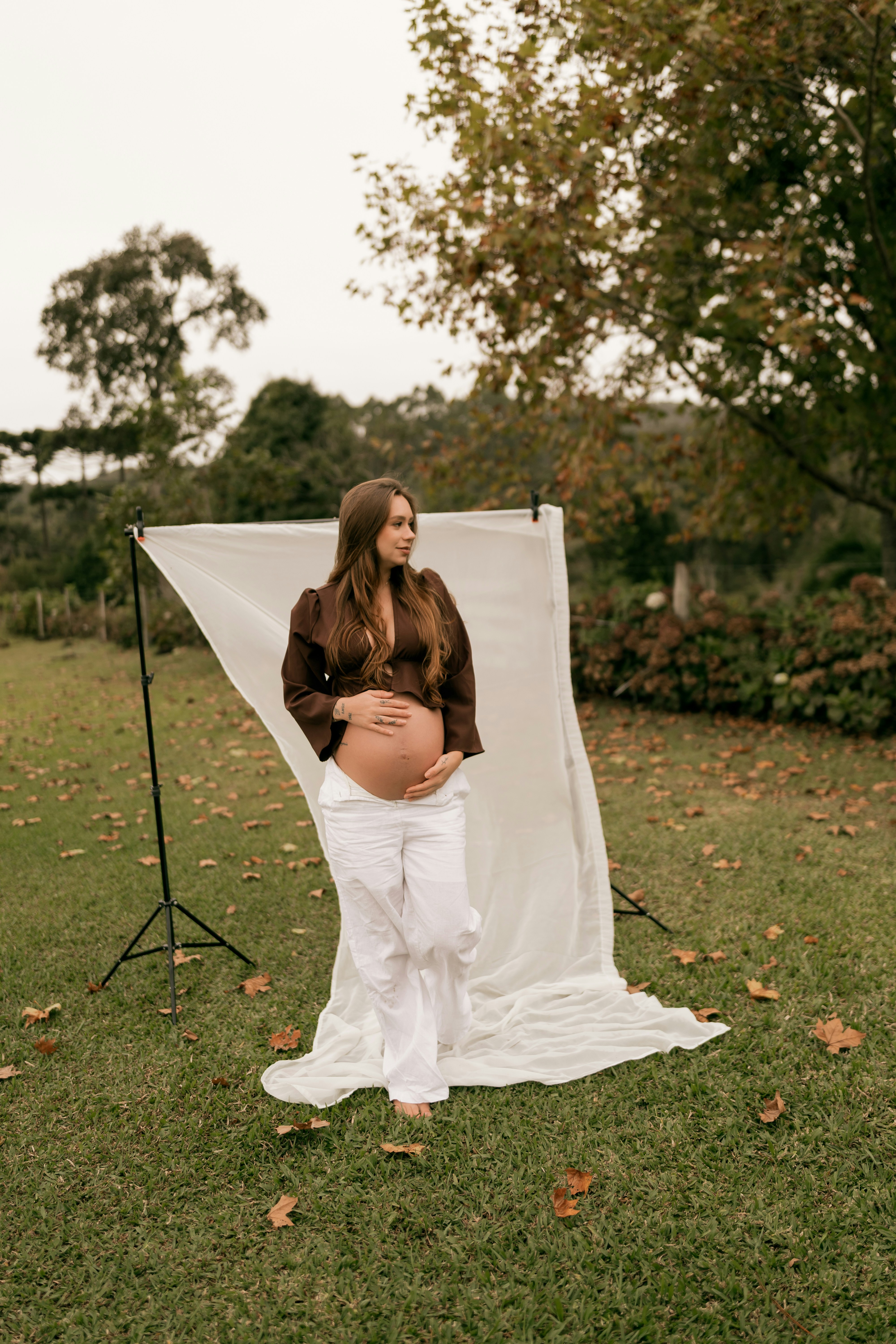 Maternity Portrait Beneath a Draped Backdrop in an Open Field
