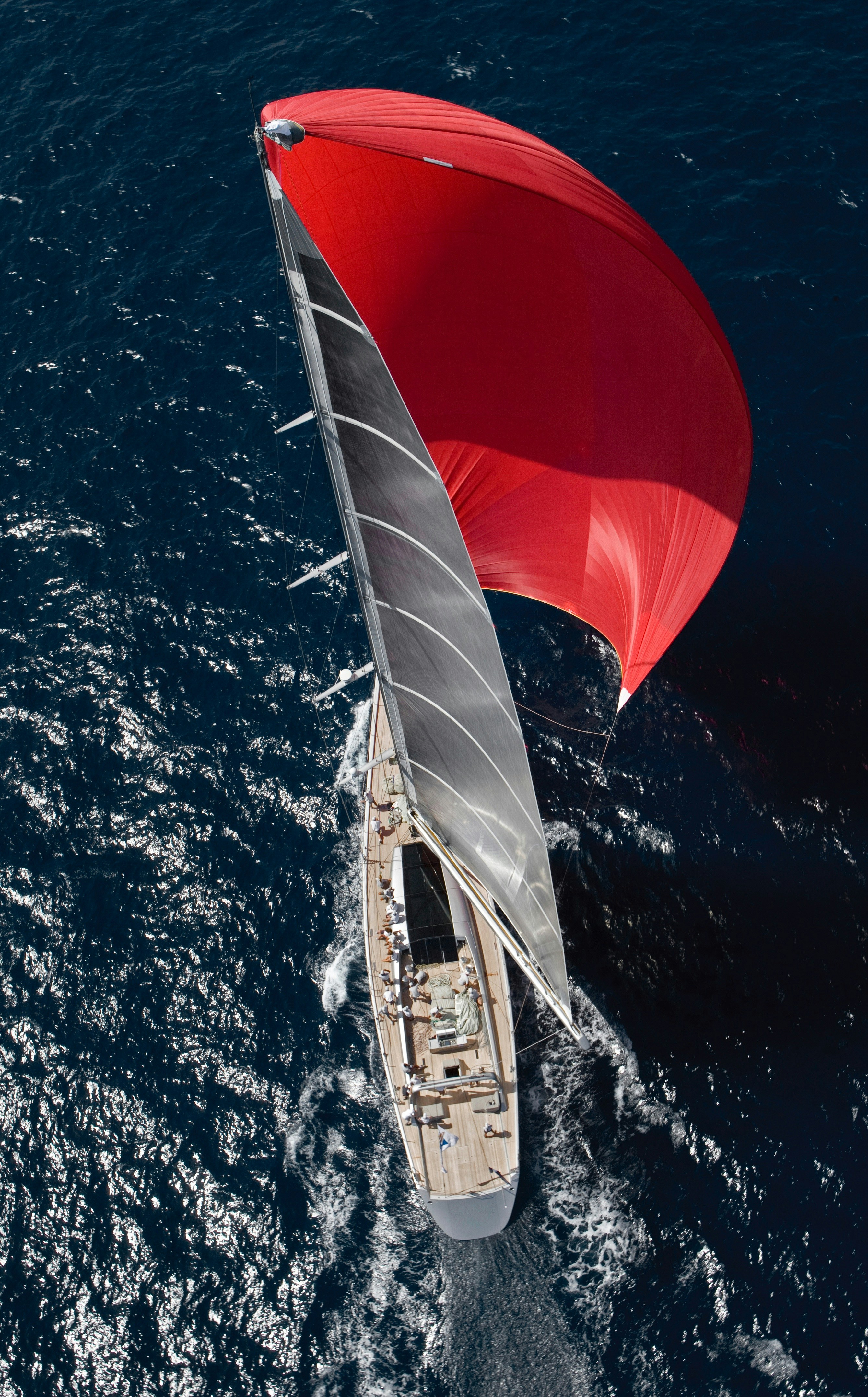 Red Spinnaker over a Quiet Blue Wake
