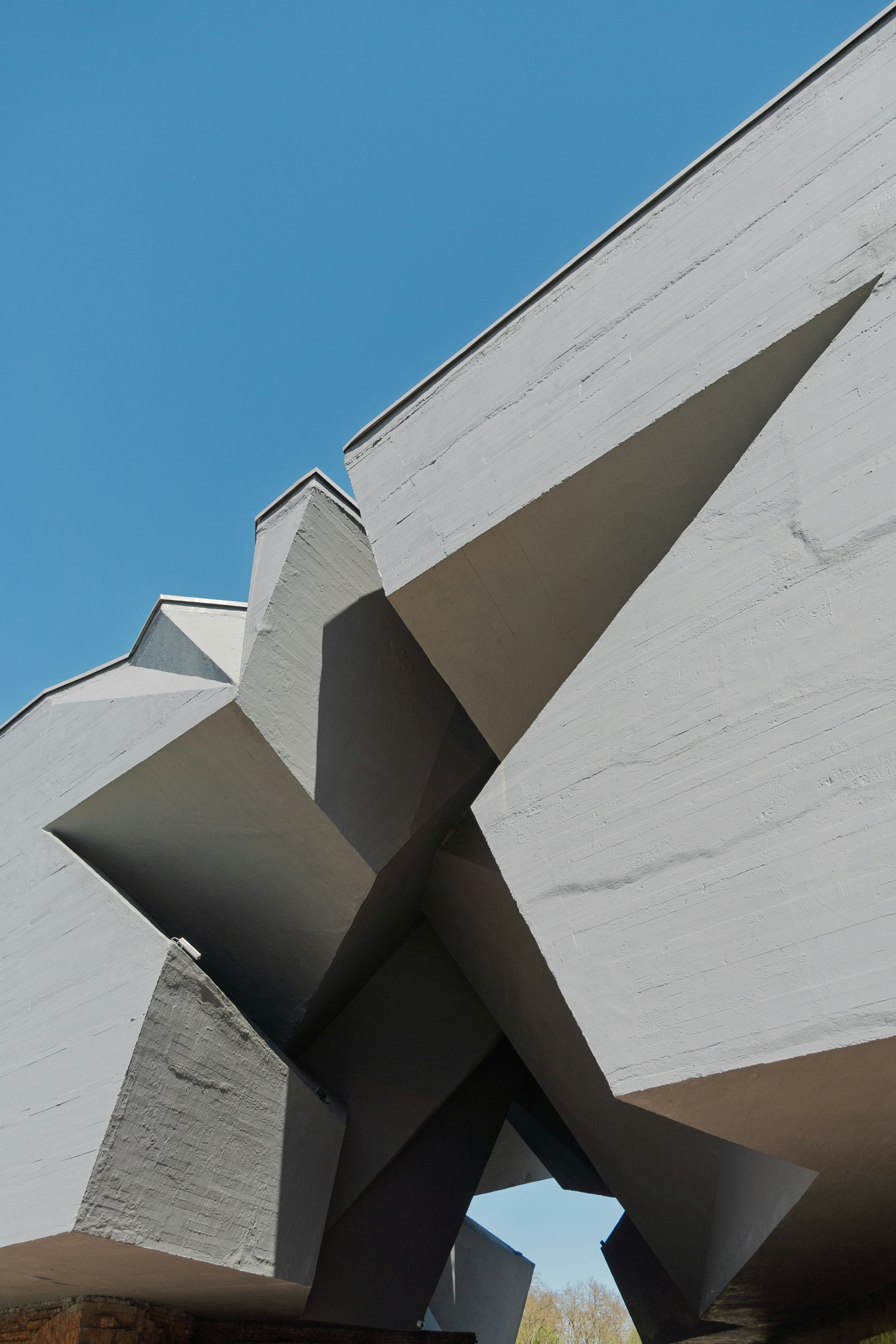 Angles of Concrete: A Study in White Geometry Against a Clear Blue Sky