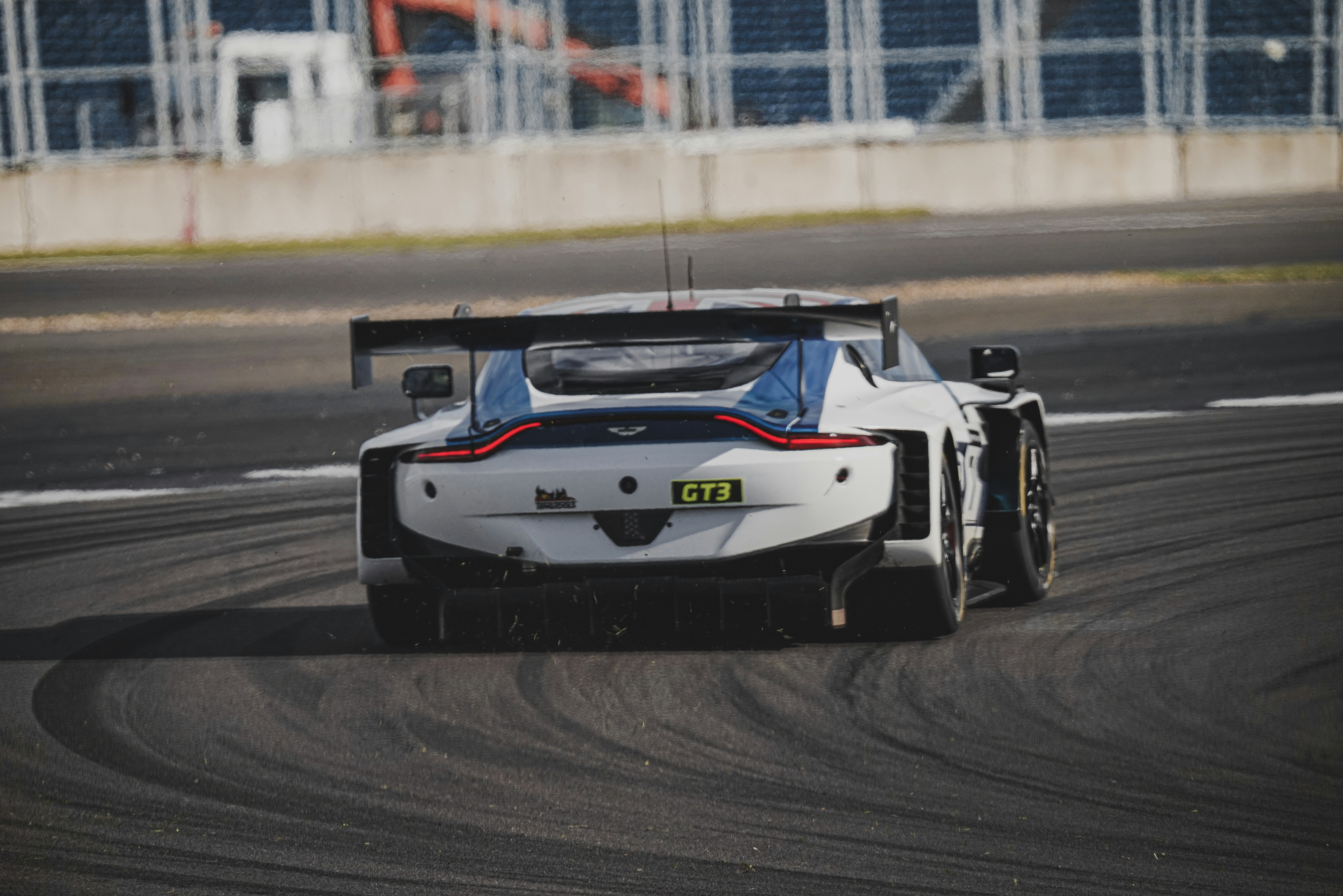 Rearward Sprint: White GT3 Cup Roaring on the Circuit