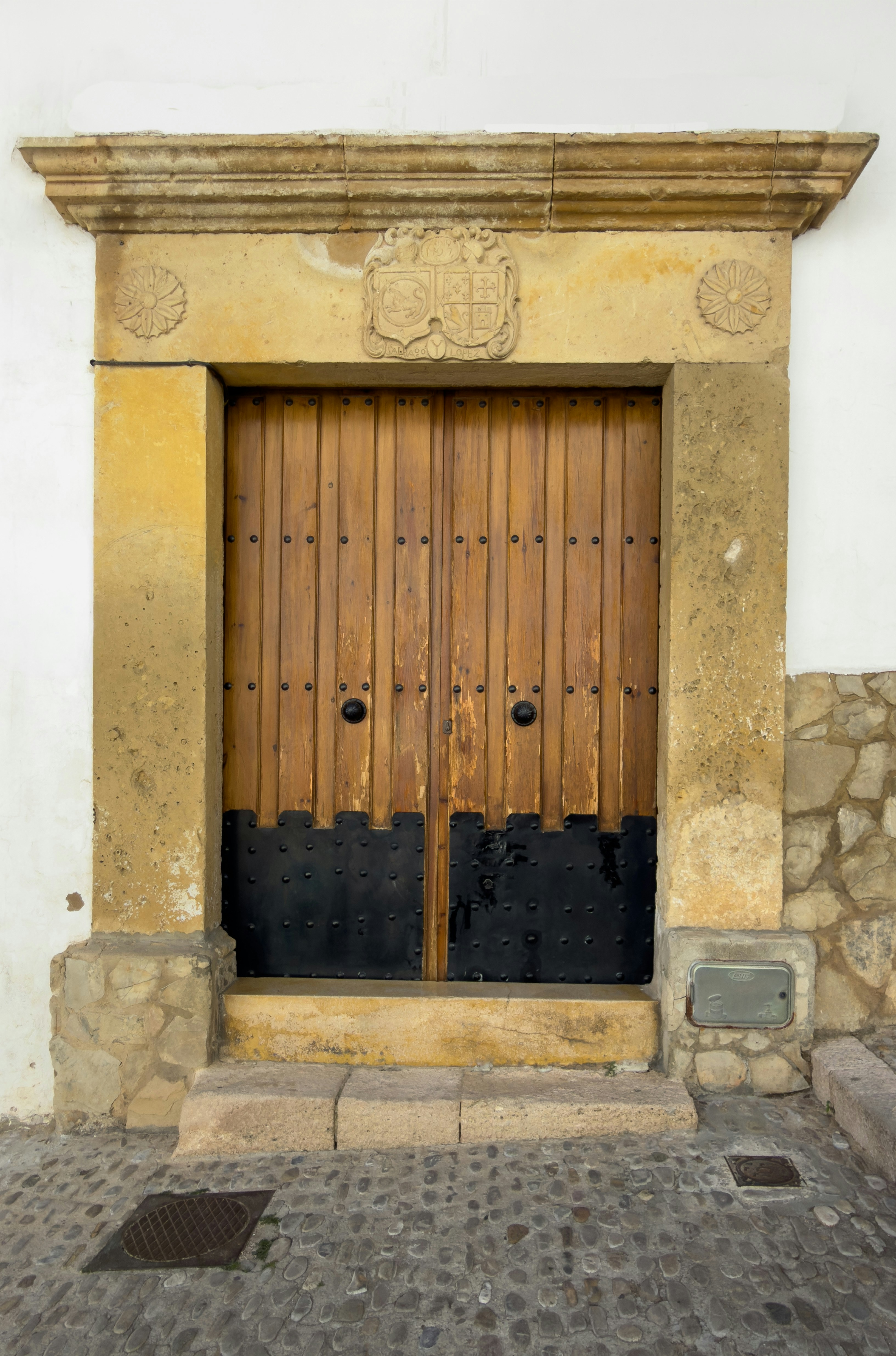 Weathered Colonial Doorway Framed by Stone and Shadow
