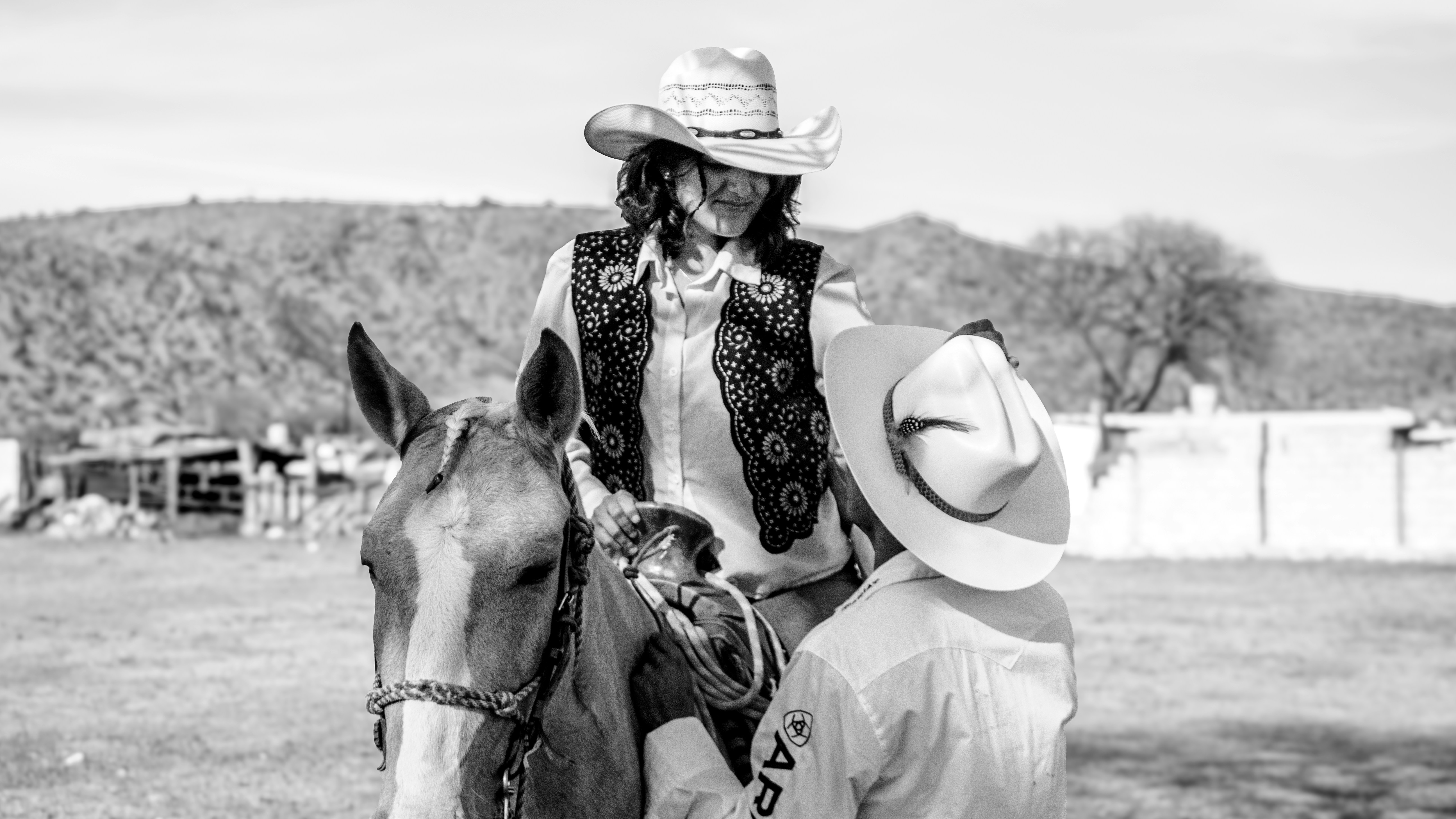 Cowgirl Crossing Paths: A Quiet Conversation in the Ring