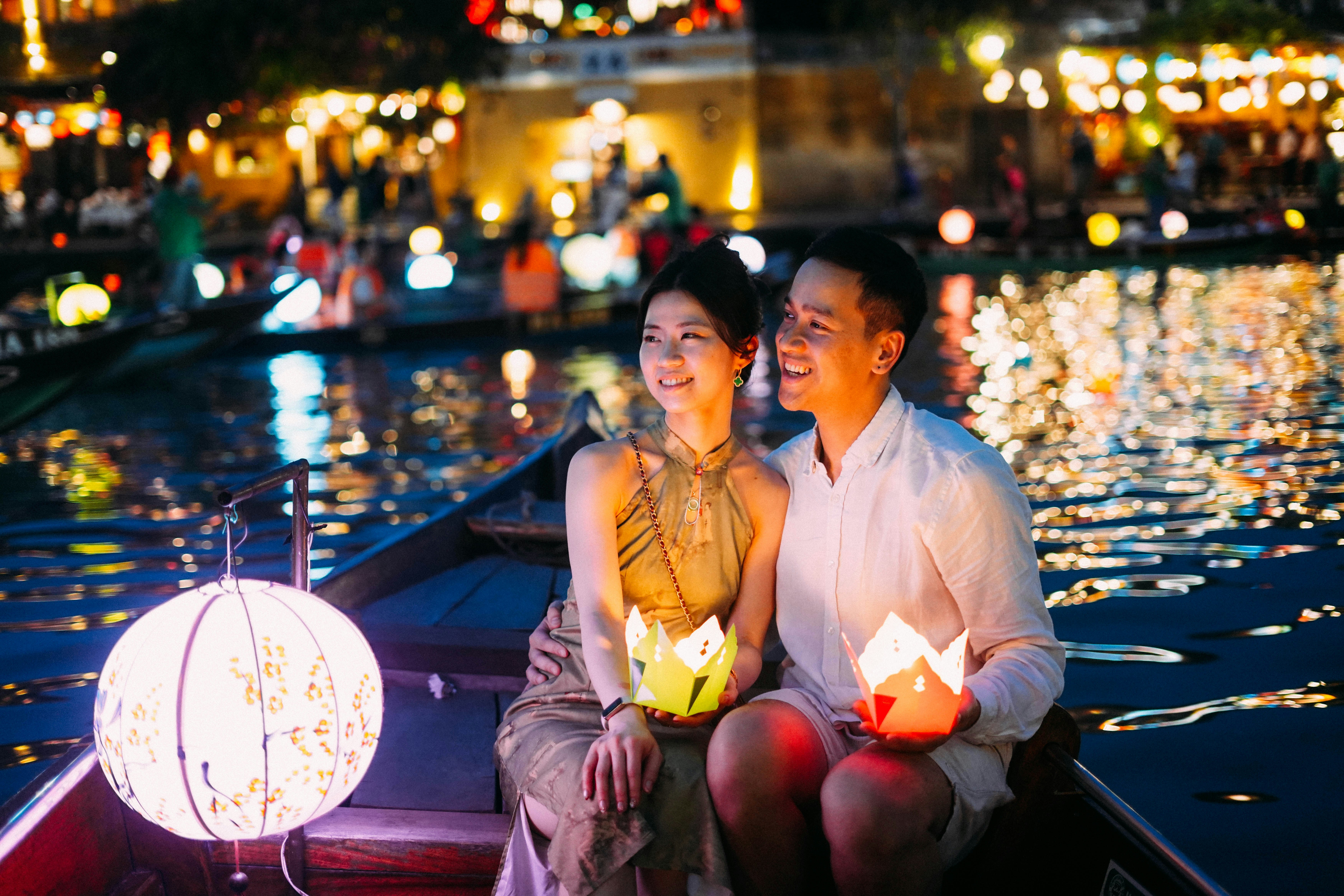 Moonlit Embrace: Lantern-lit Couple on a Serene River Scene