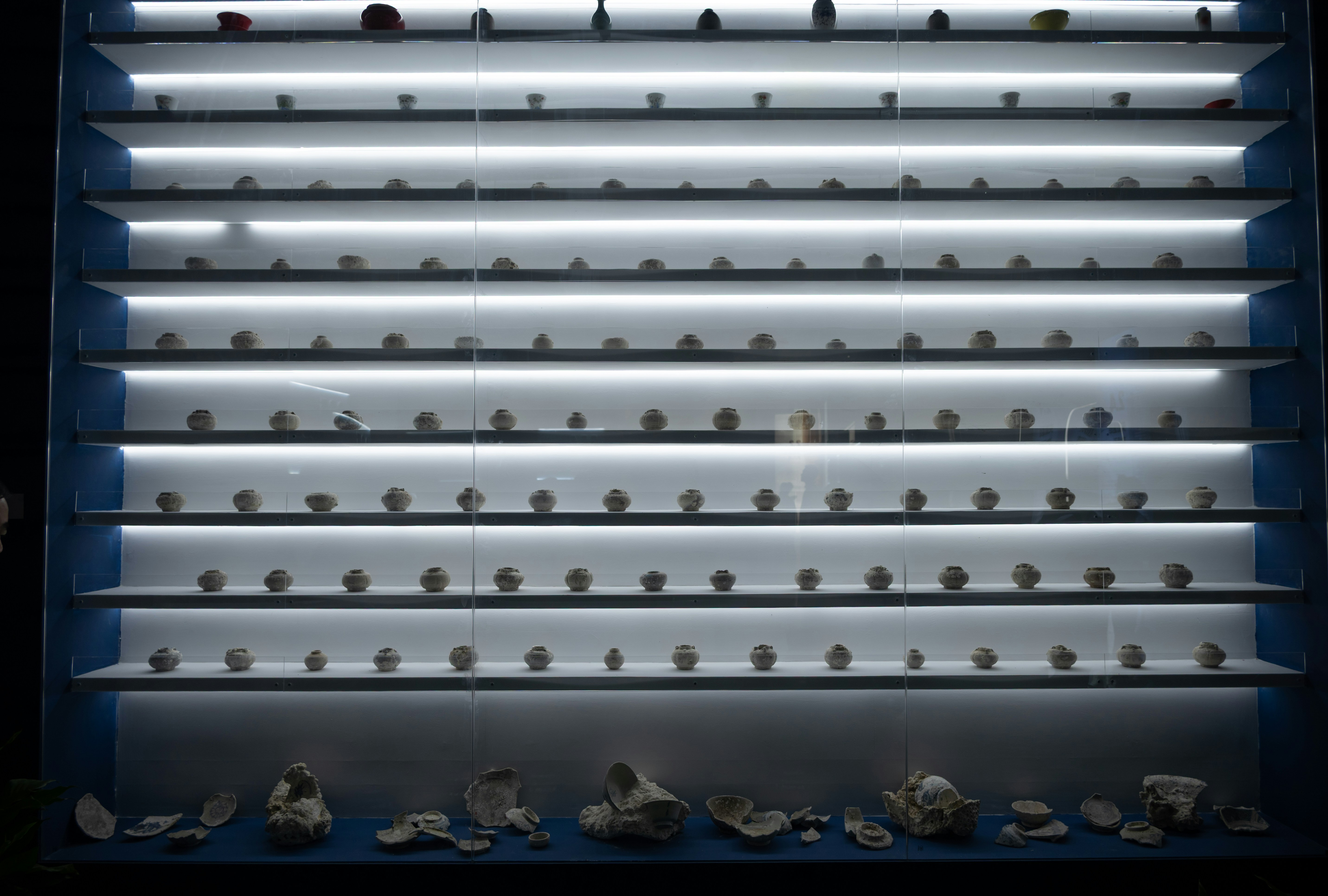 Row by Row: Shoes on Display Behind Horizontal Slats