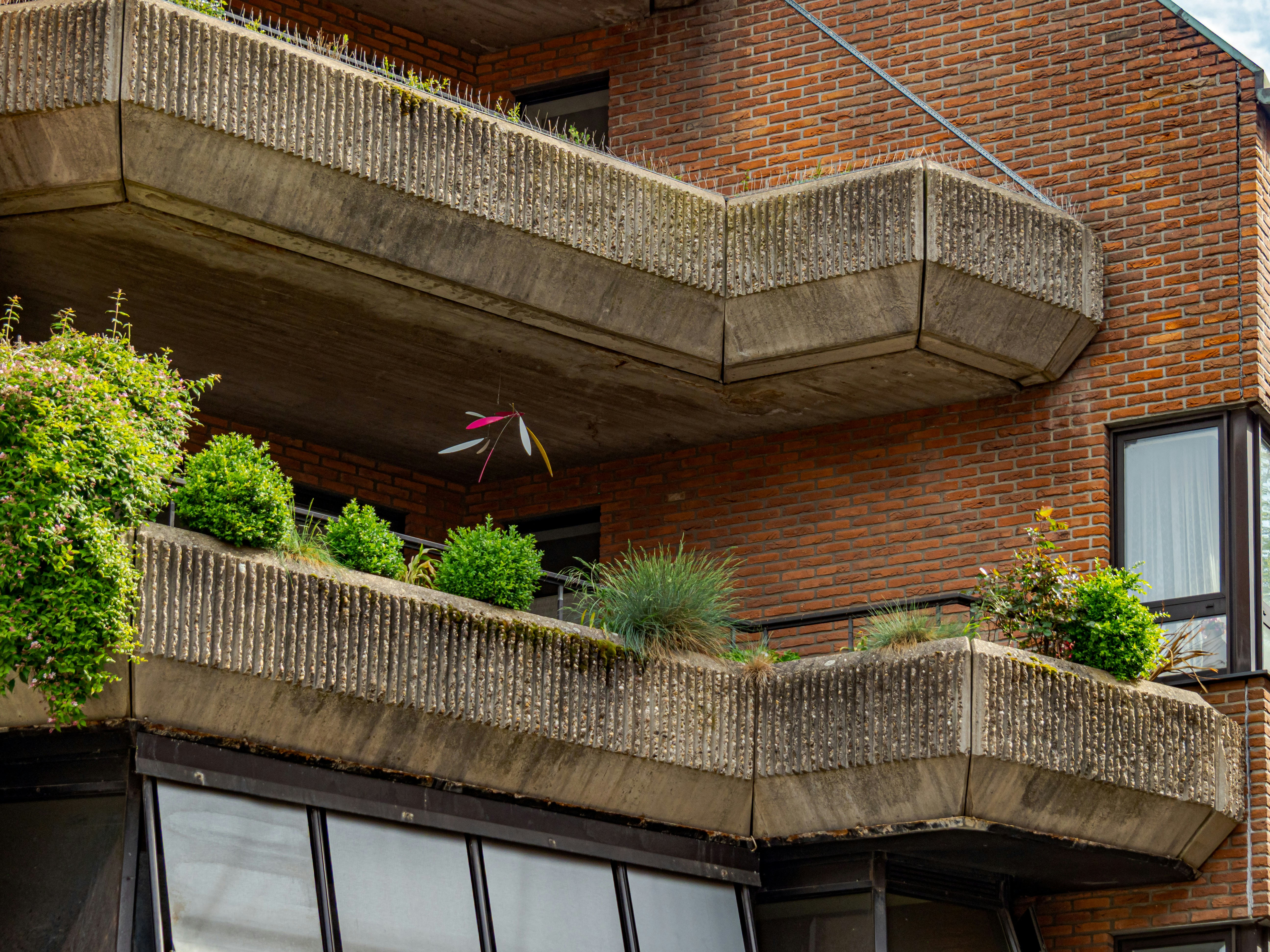 Balconies with In-Flight Ribbon: A Moment Over Concrete Planters