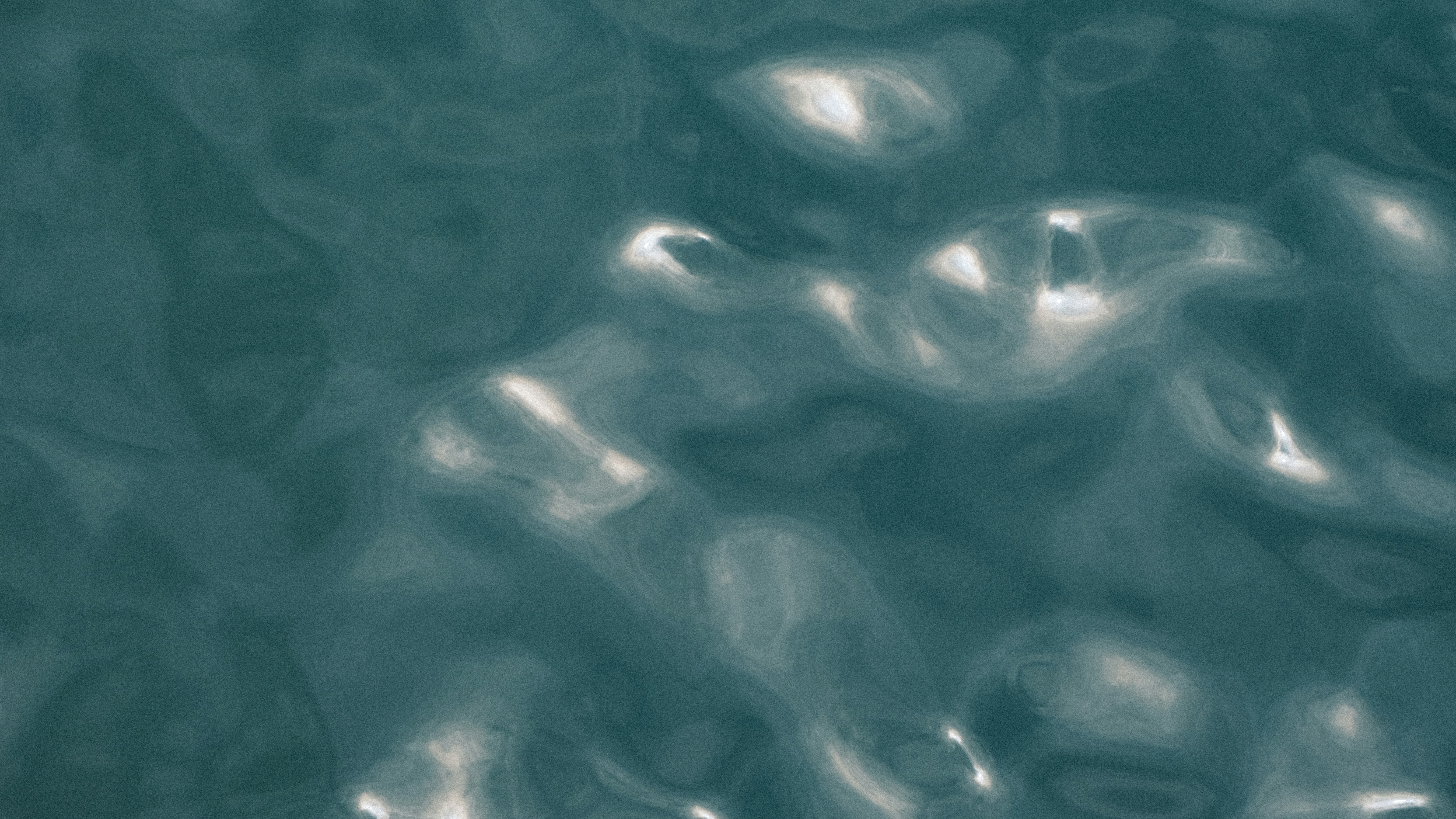 Rippling blue water with sunlight reflections