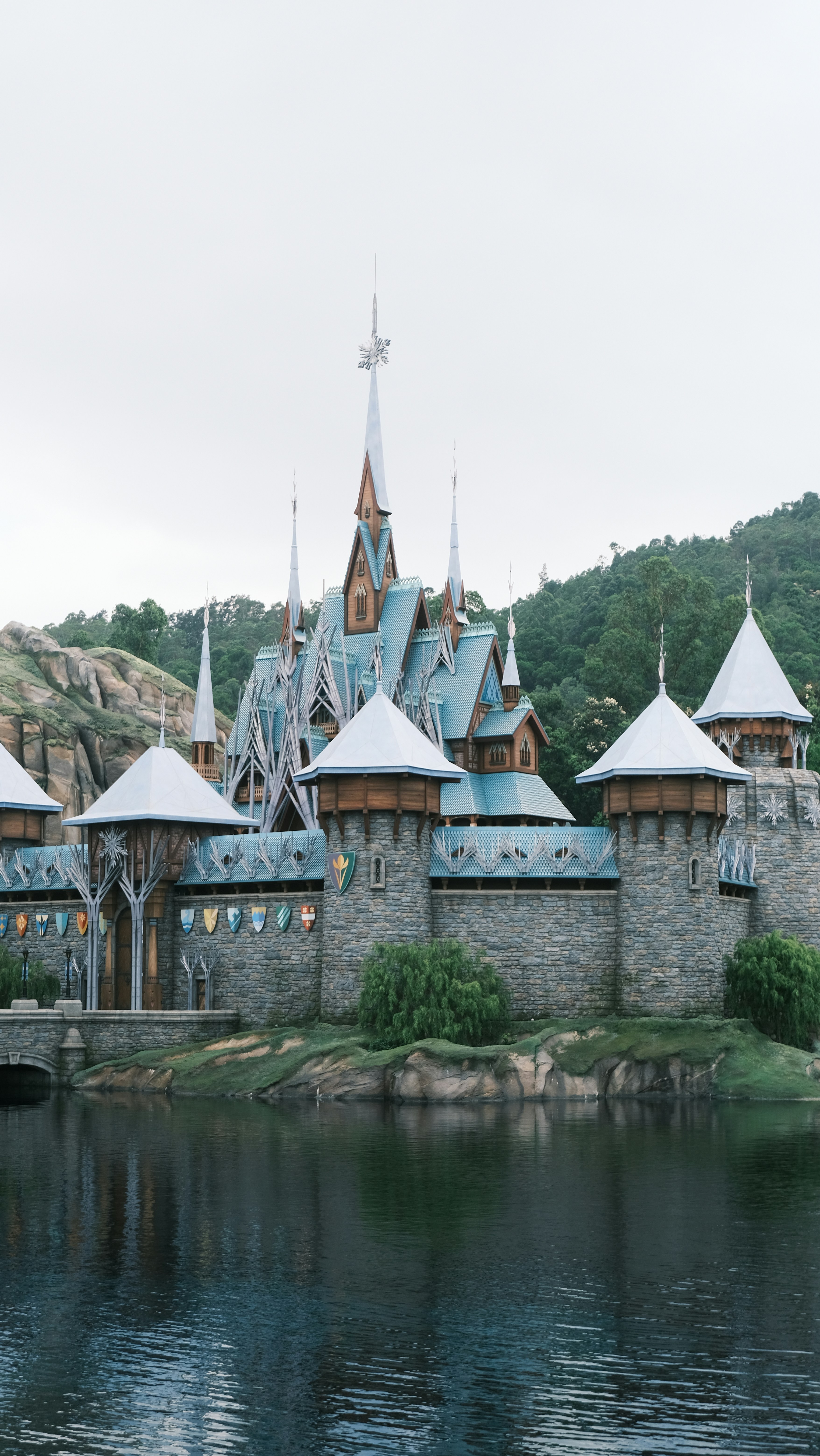 Castle by the Waterfront: A Fairytale Fortress against a Misty Sky