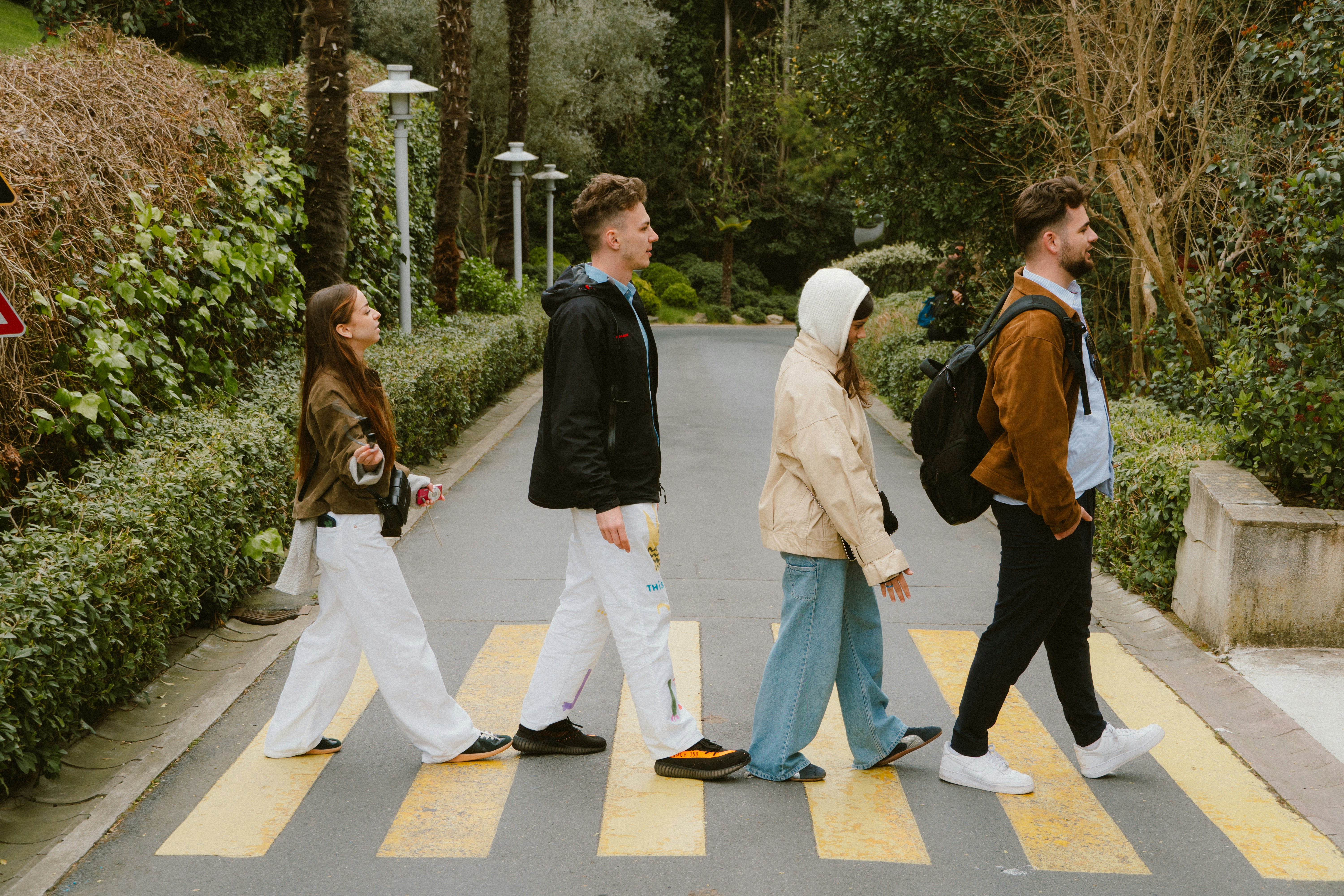 Pedestrians in a Quiet Crosswalk: A Quiet Parade Across the Yellow Strips
