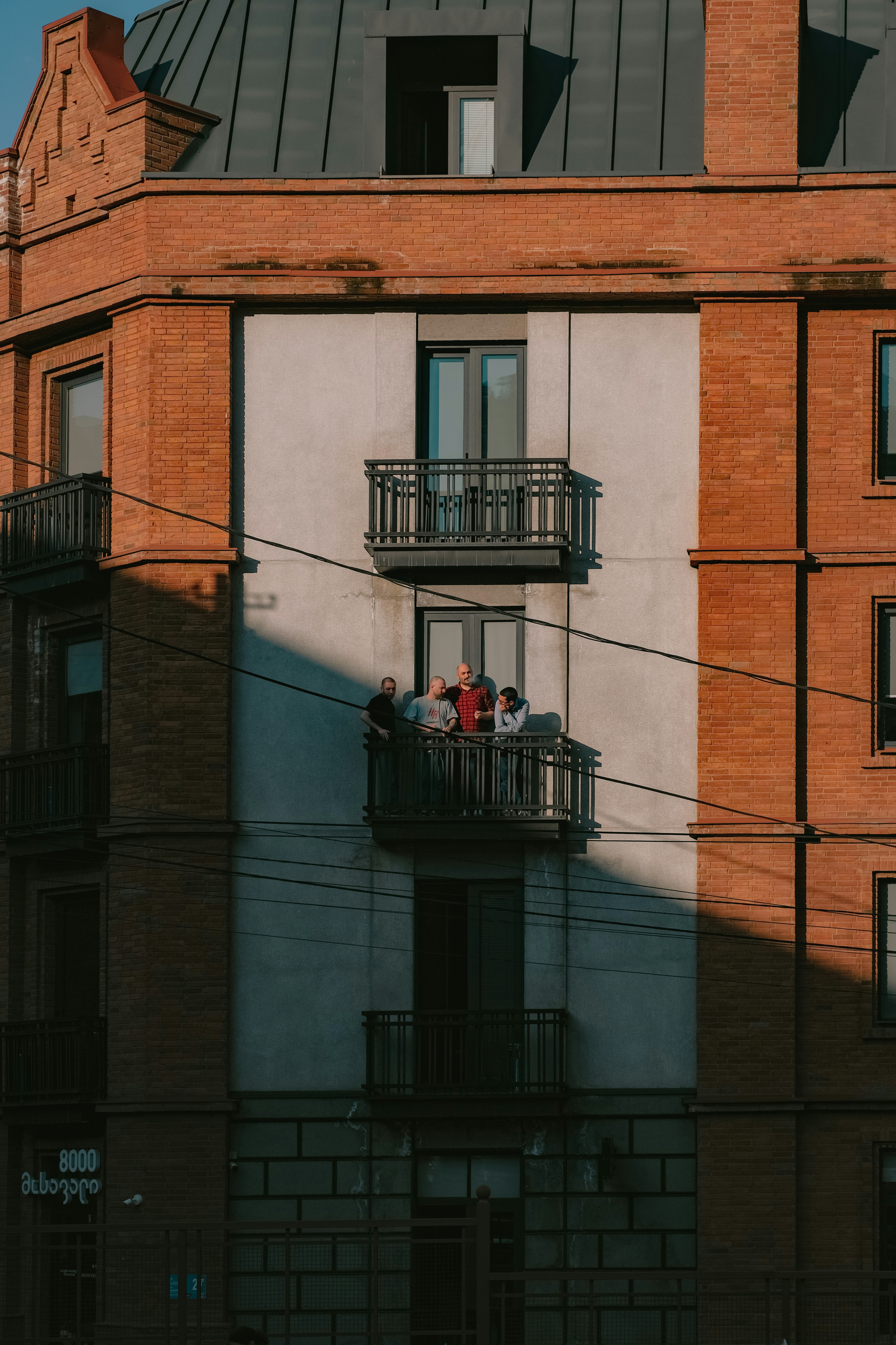 Balcony Assembly on a Sunlit Brick Facade