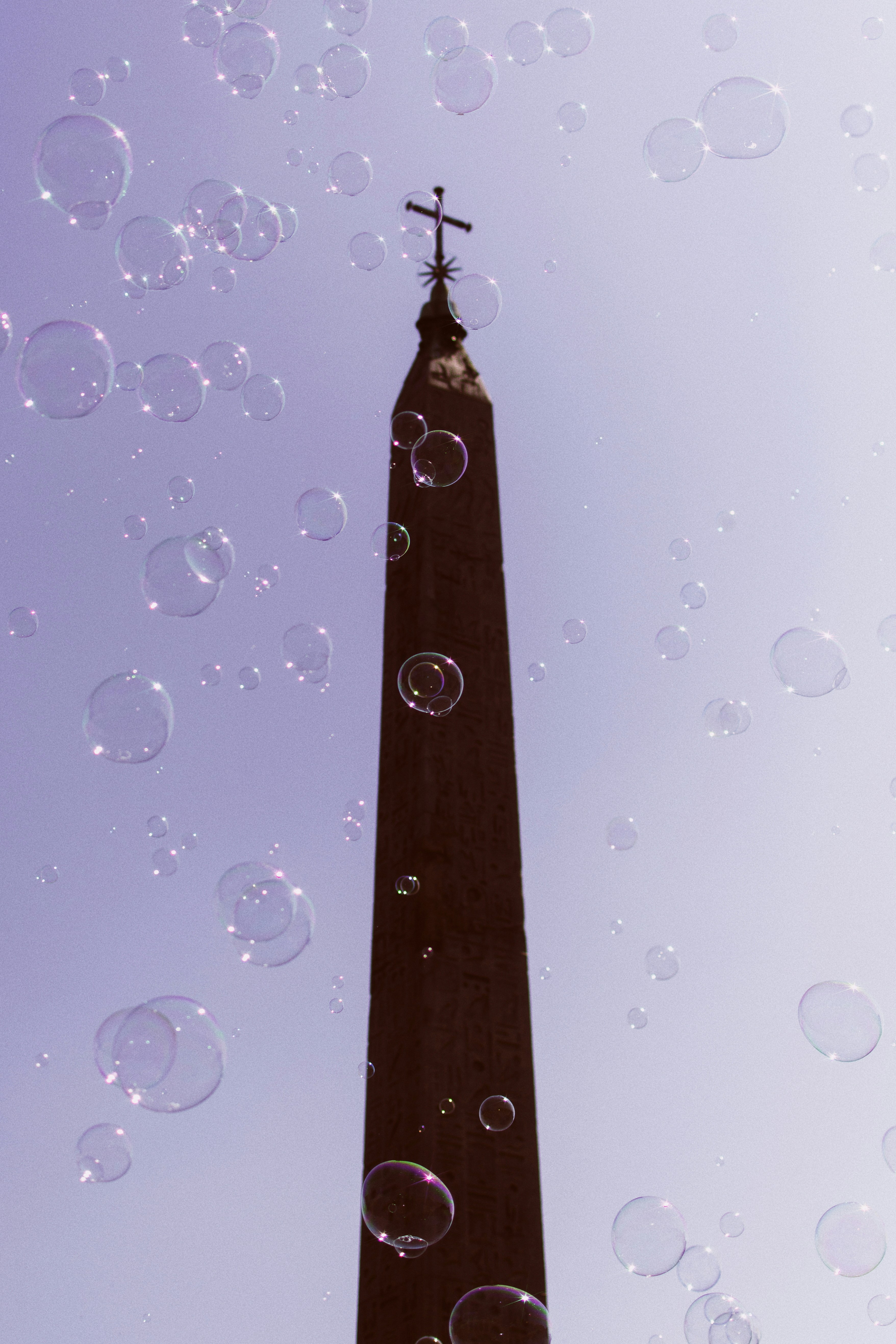 Obelisk Under Bubbles: A Skyward Still-Life with Soapy Orbits