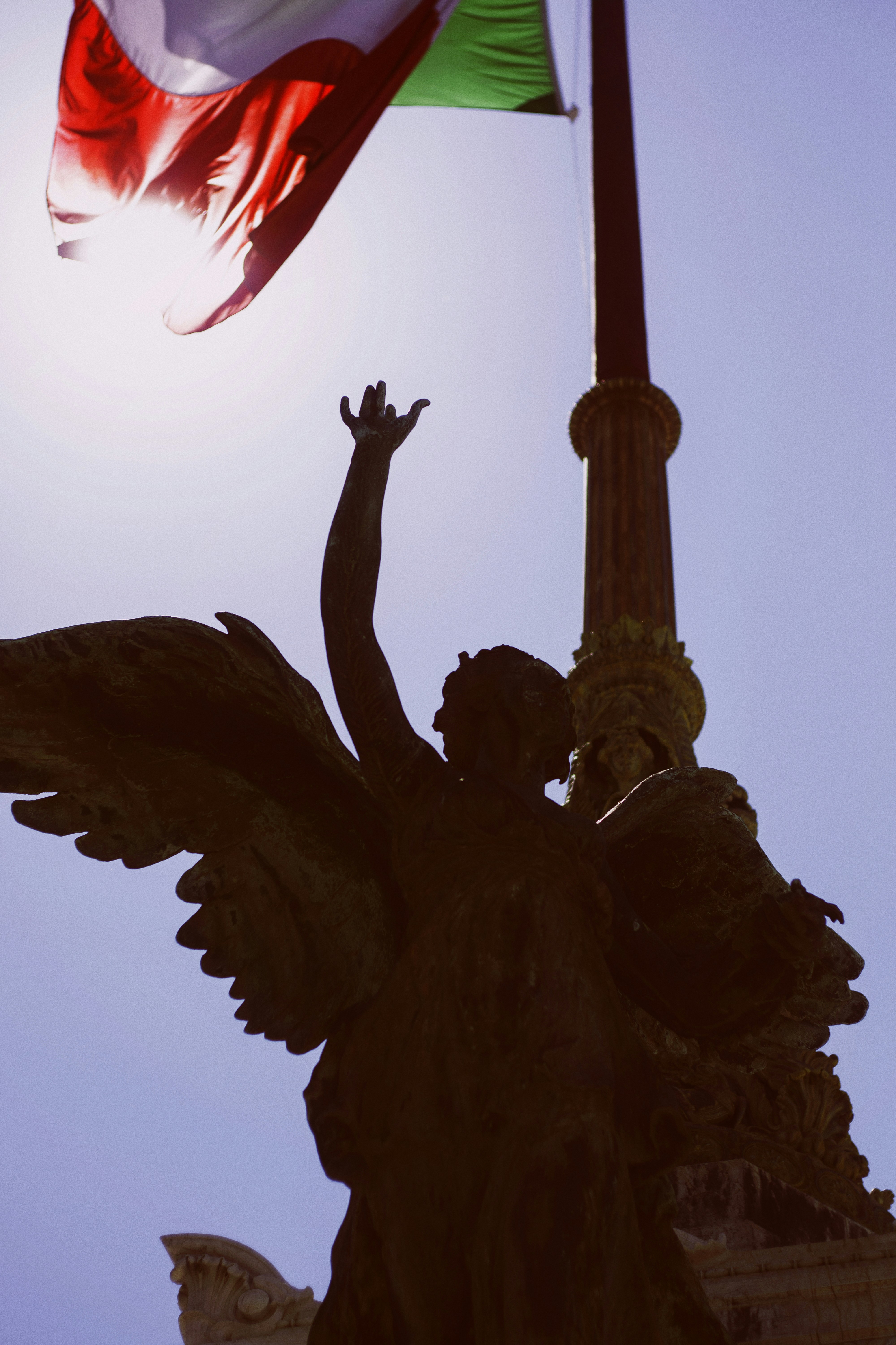 Winged Silence Under the Flag: A Monumental Gesture in Backlight
