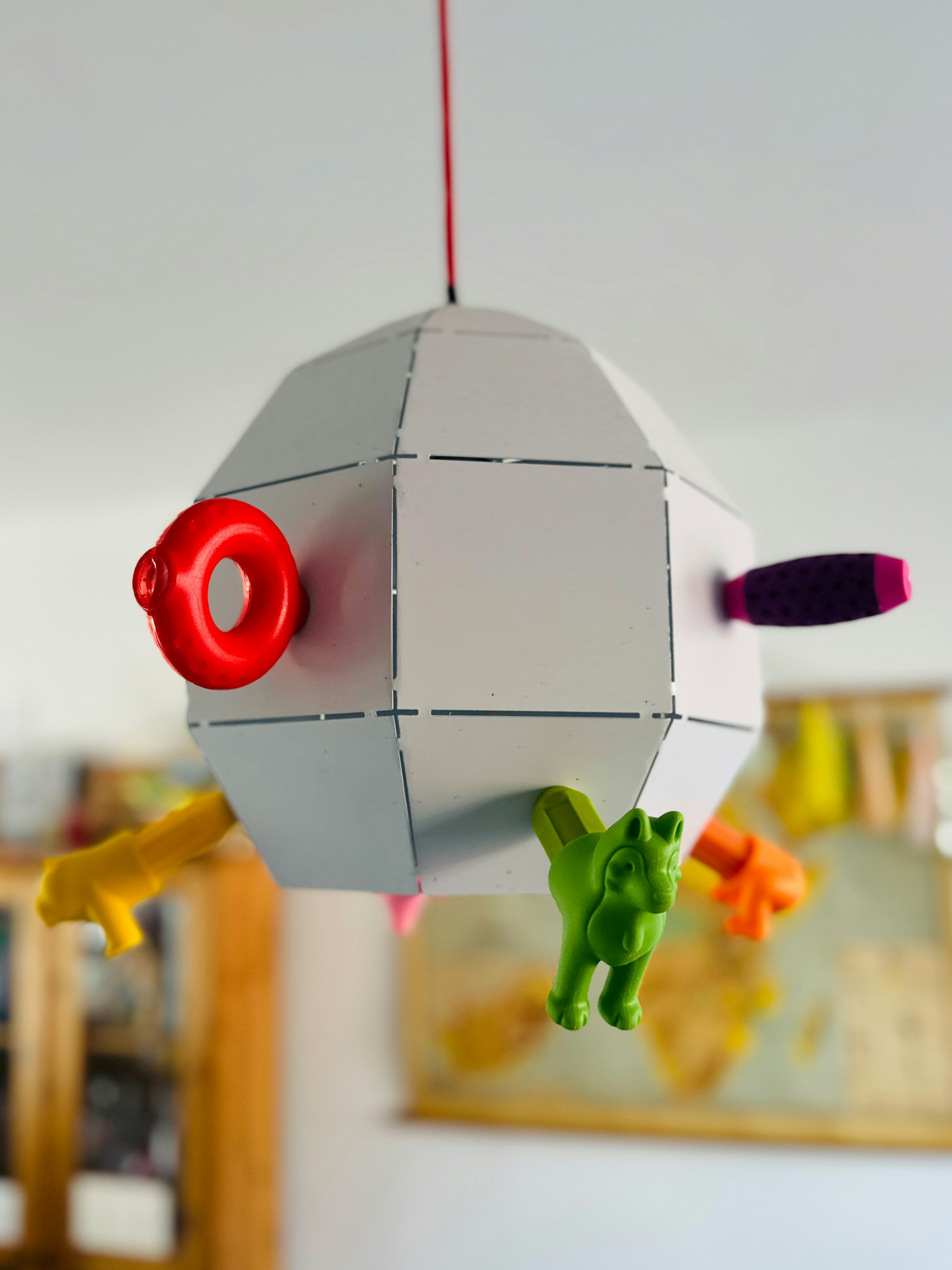 Floating Geometric Shuttle Toy with Clip Arms