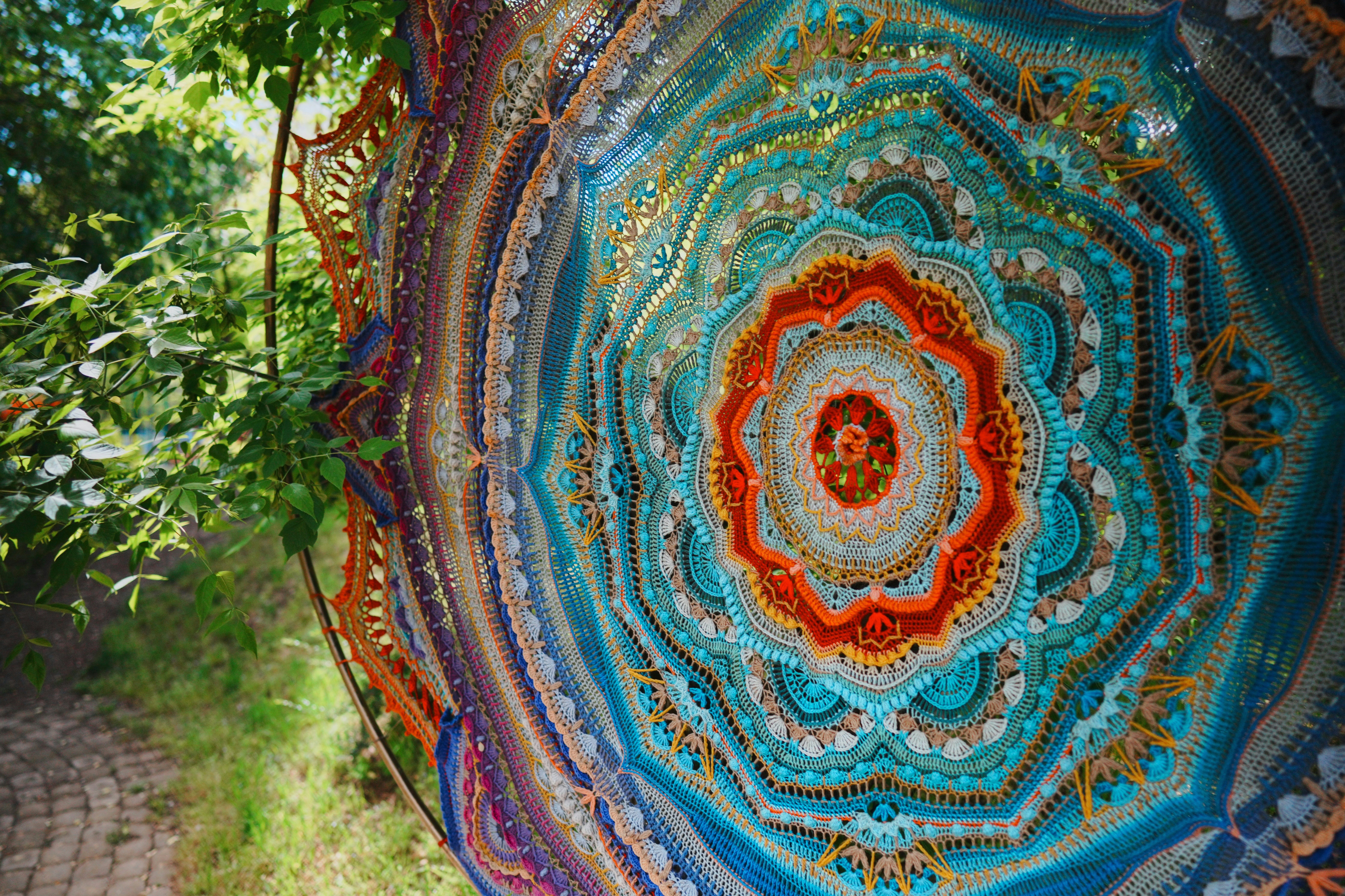 Kaleidoscopic mandala under a sunlit canopy