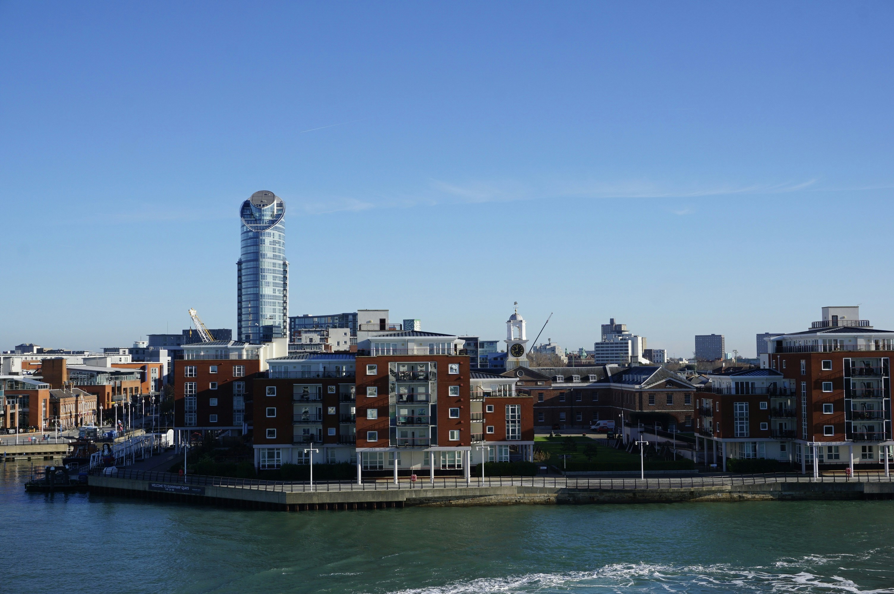 City Edge: Boats, Brick, and Glass Skyscrapers by the Wharf