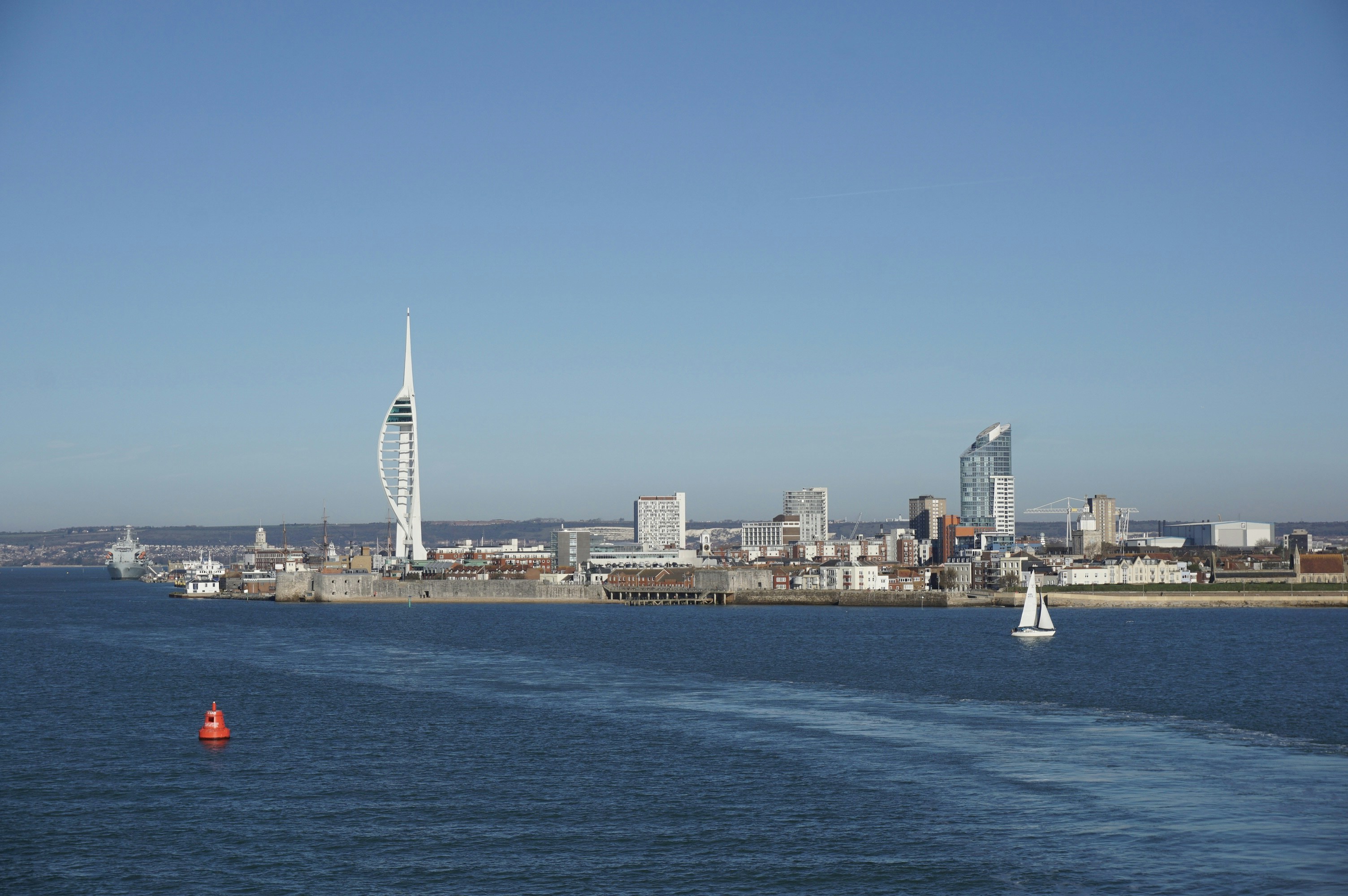 Harbor Edge: City Skyline with Sailboat