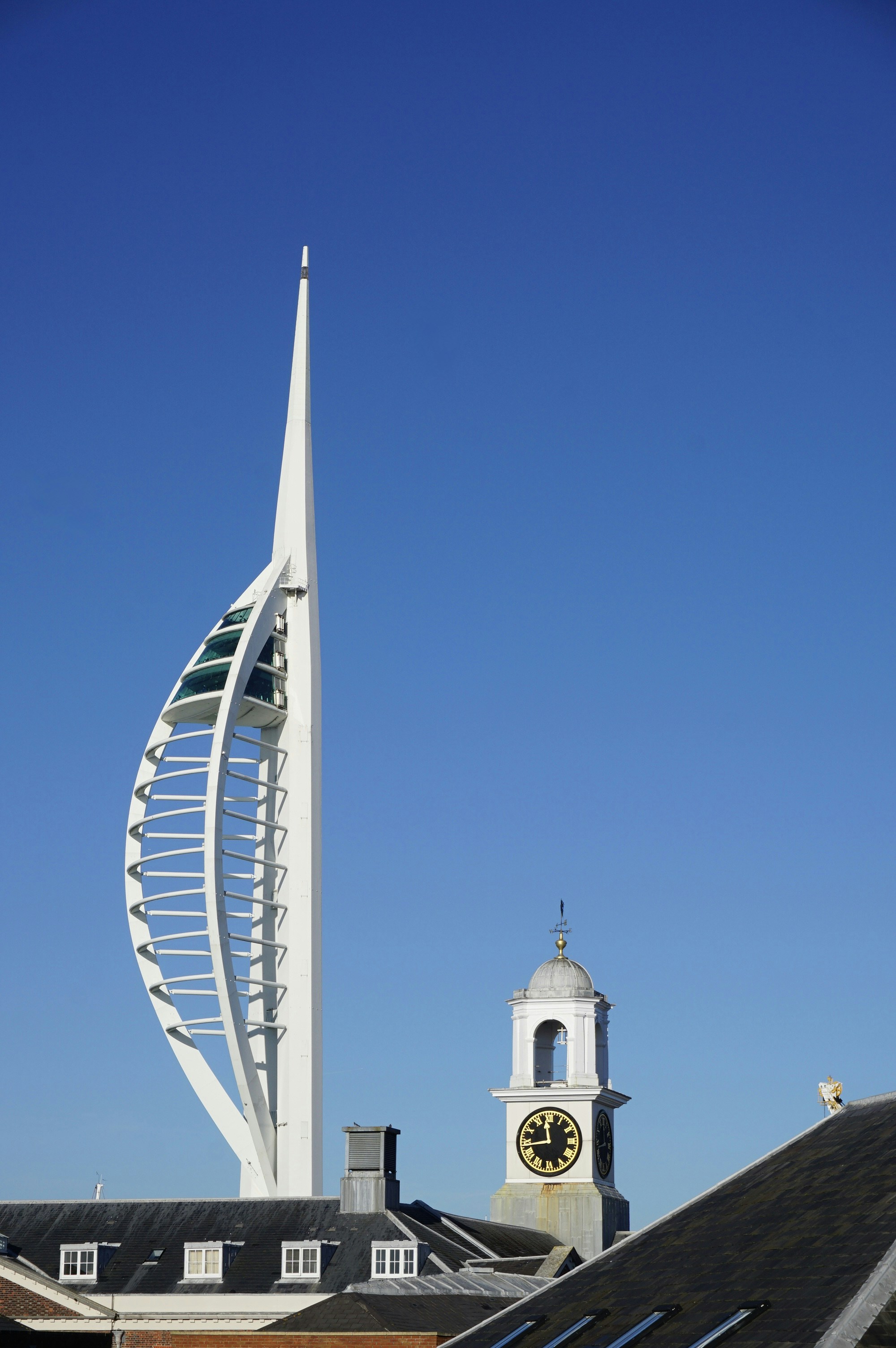 Spire and Clock: A Modern Needle Against a Timeless Sky