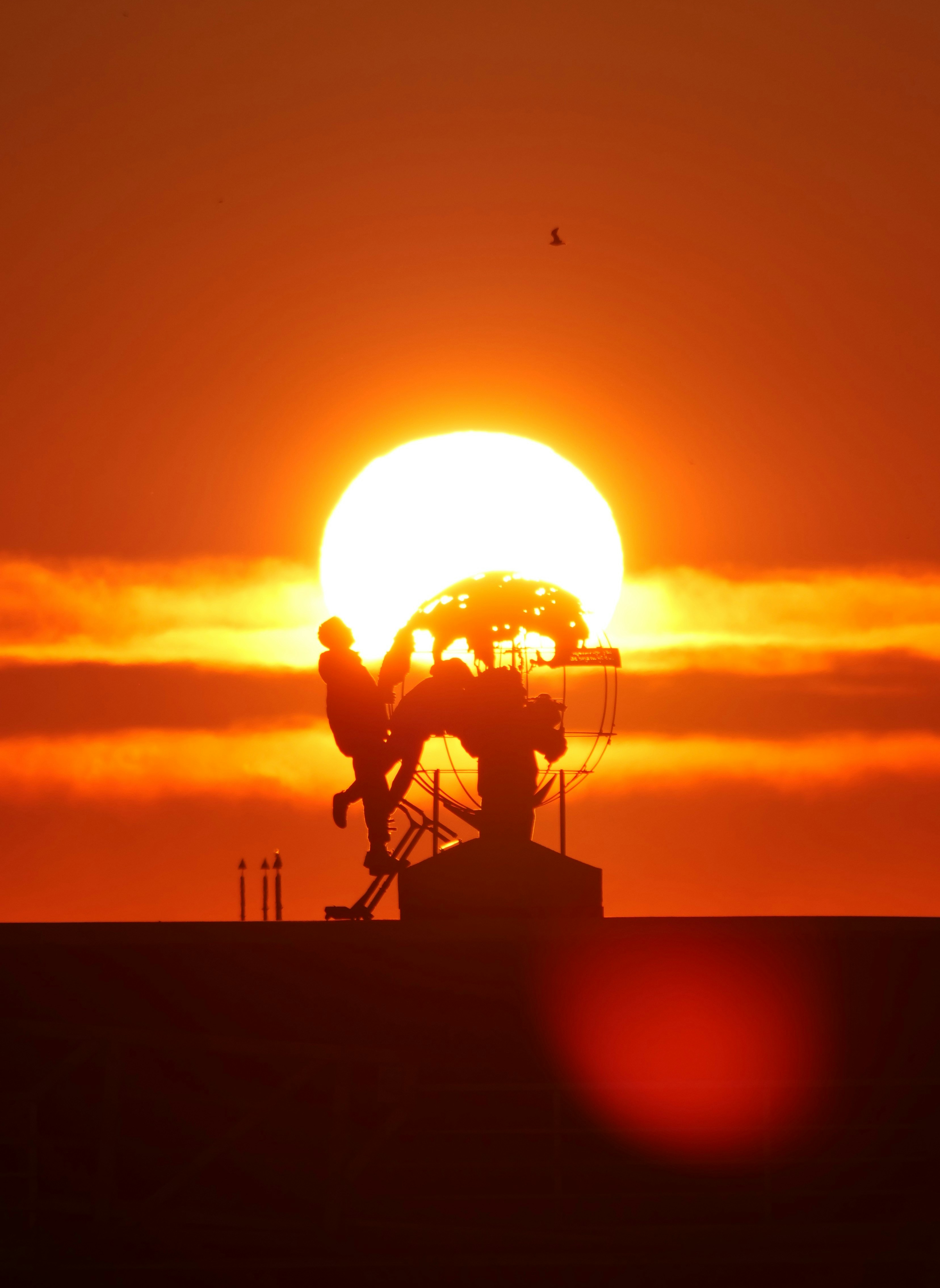 Sunlit Silhouette: Technician at the Edge of a Rooftop Instrument